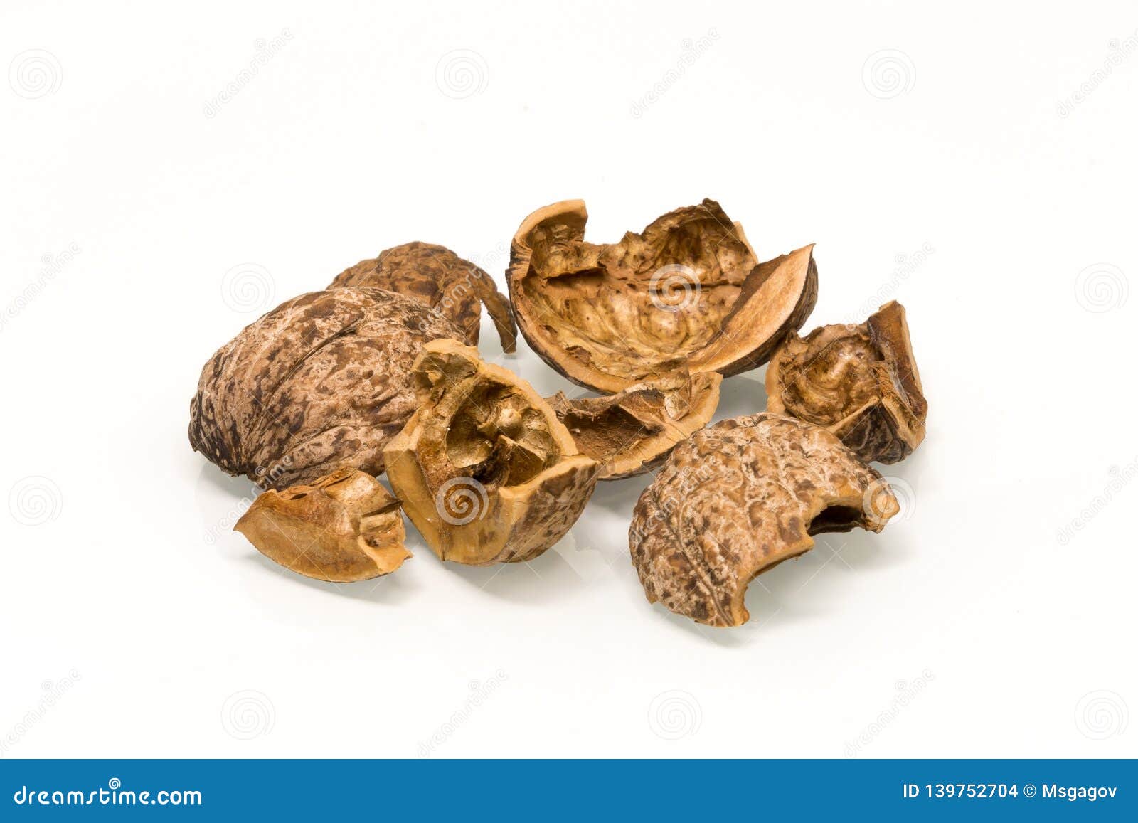 Cracked walnut shells stock photo. Image of background - 139752704