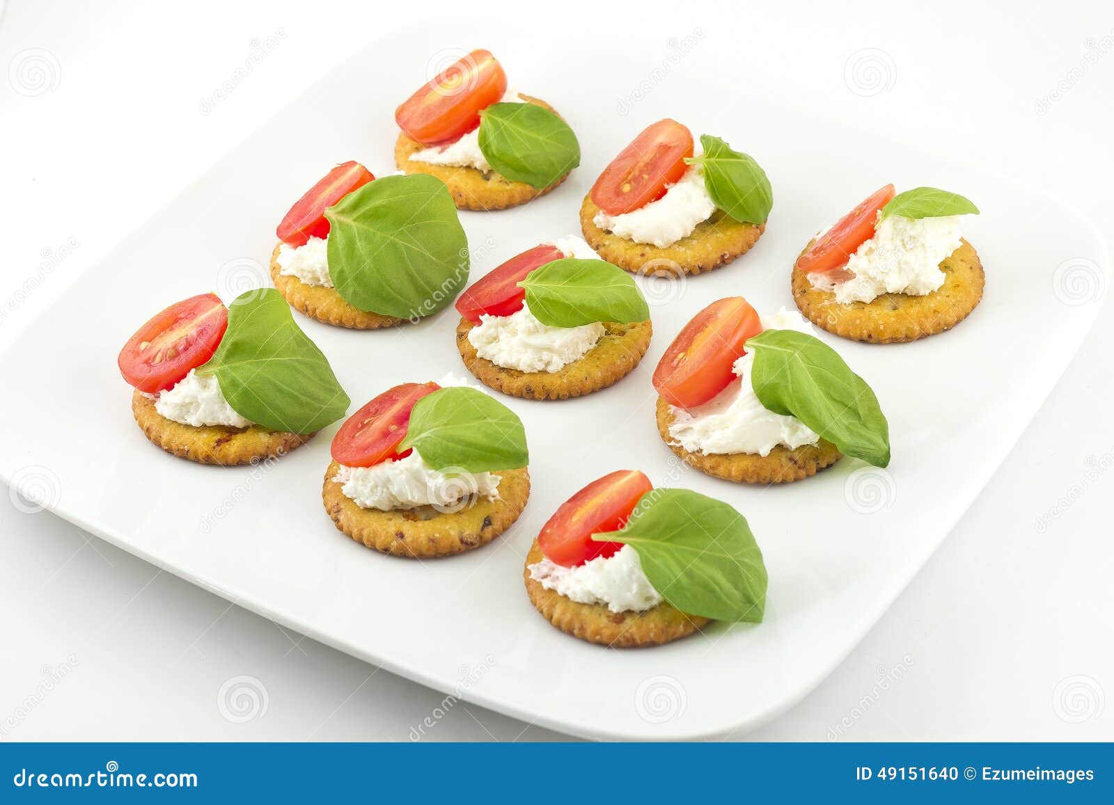 Crackers with Cheese Tomato and Basil Stock Photo - Image of food ...