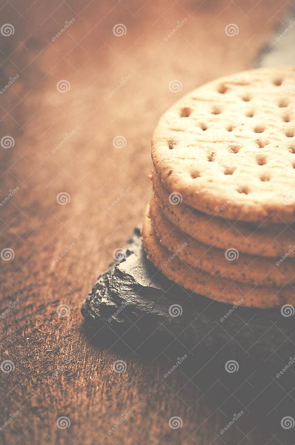 Crackers Stack Together on Black Stone, Wooden Background.Copy S Stock ...