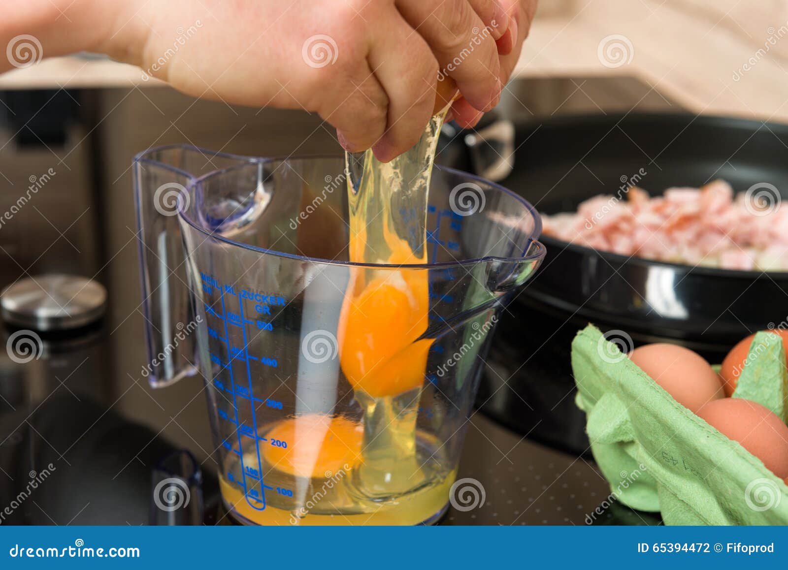 Cracking Eggs for Breakfast Cooking in a Modern Kitchen Stock Photo ...