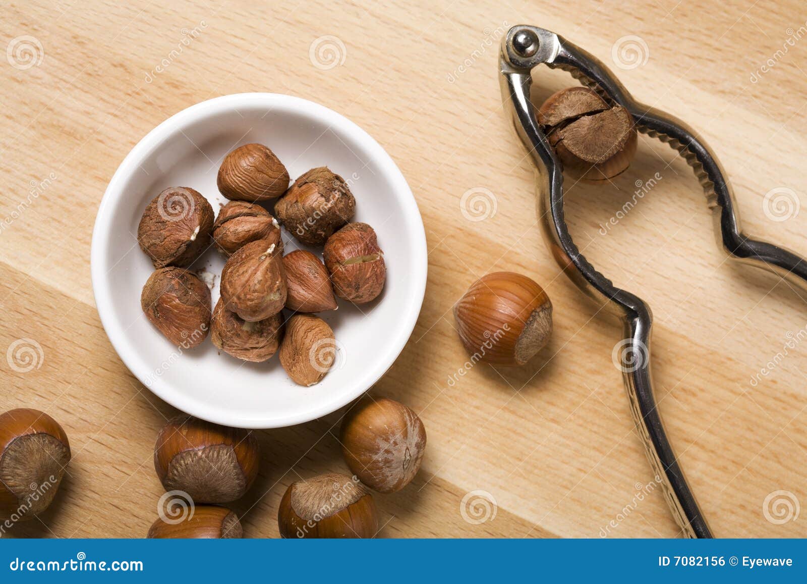 Cracking hazelnuts stock photo. Image of bowl, nutcracker - 7082156
