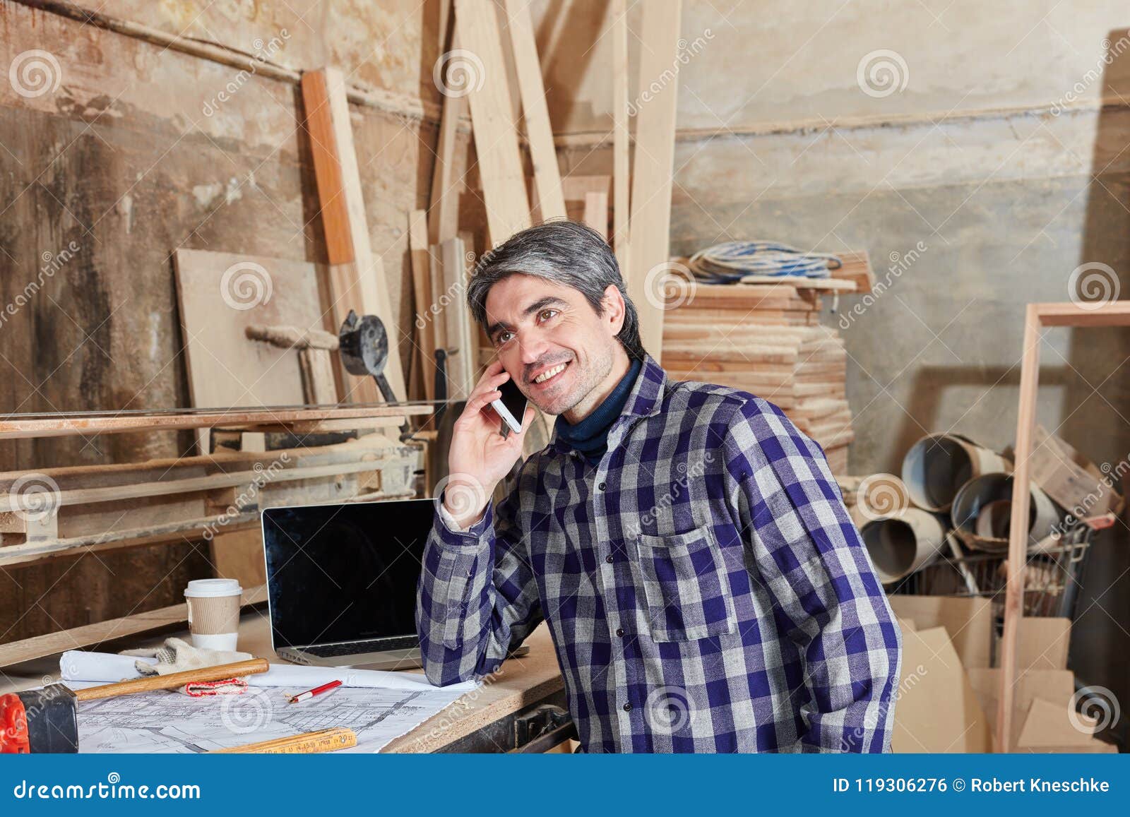 Craftsman with cell phone stock photo. Image of master - 119306276