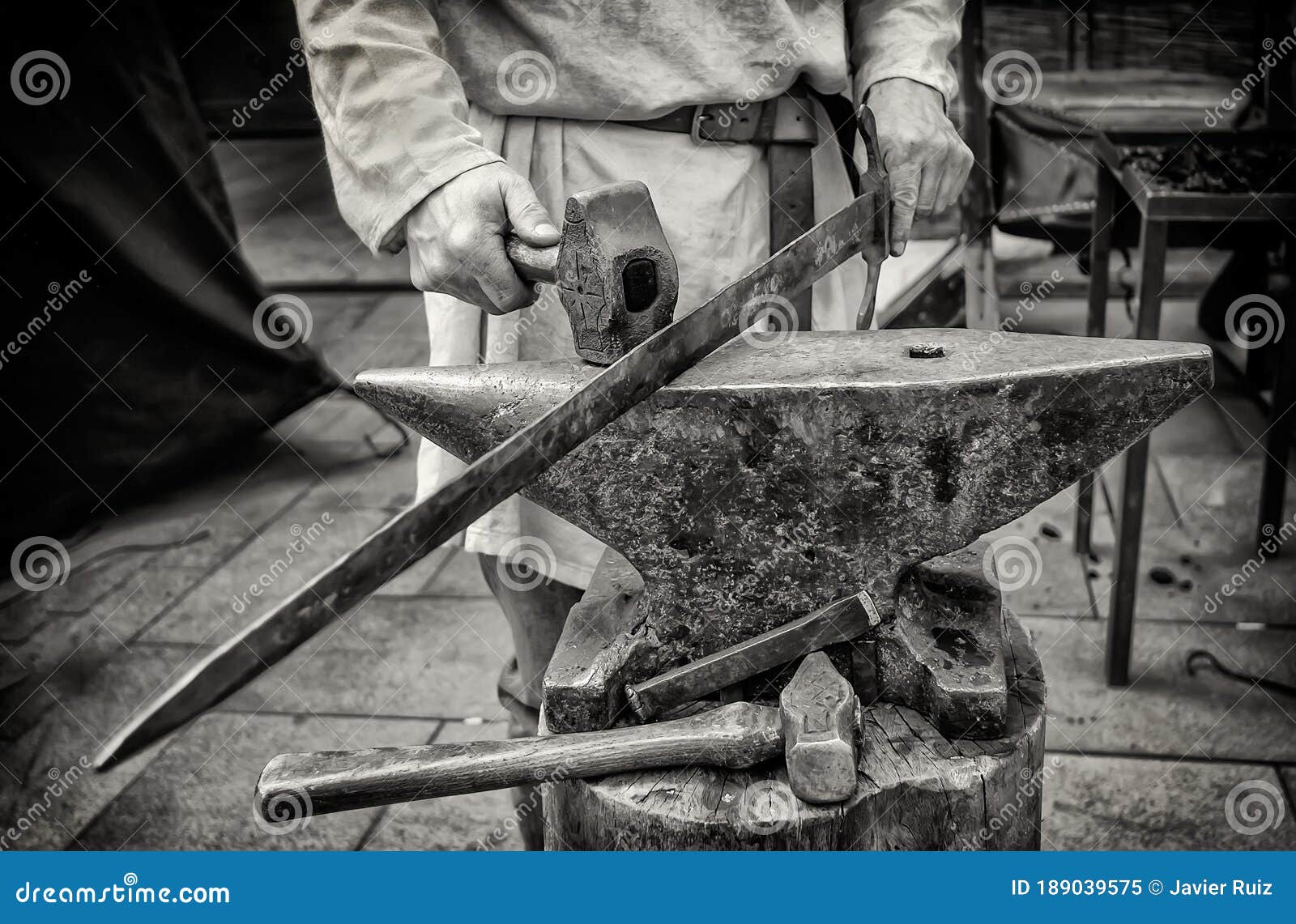 Craftsman Forging a Sword with a Hammer Blow Stock Image - Image of ...