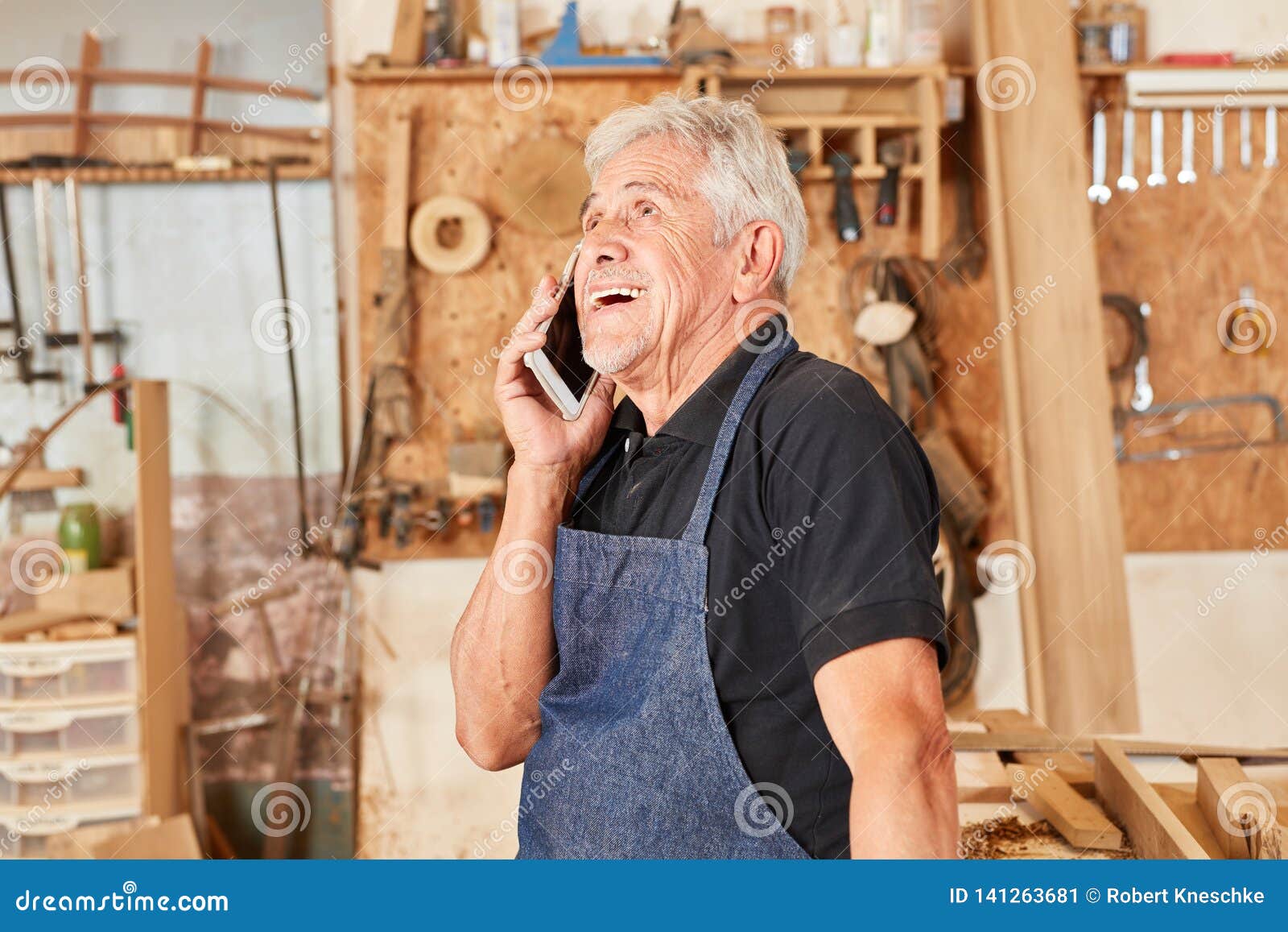 Craftsman Master with the Mobile Phone Stock Image - Image of blue ...