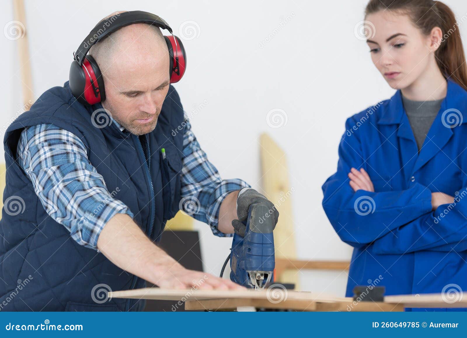 Craftsman with Pretty Female Apprentice in Workshop Stock Image - Image ...