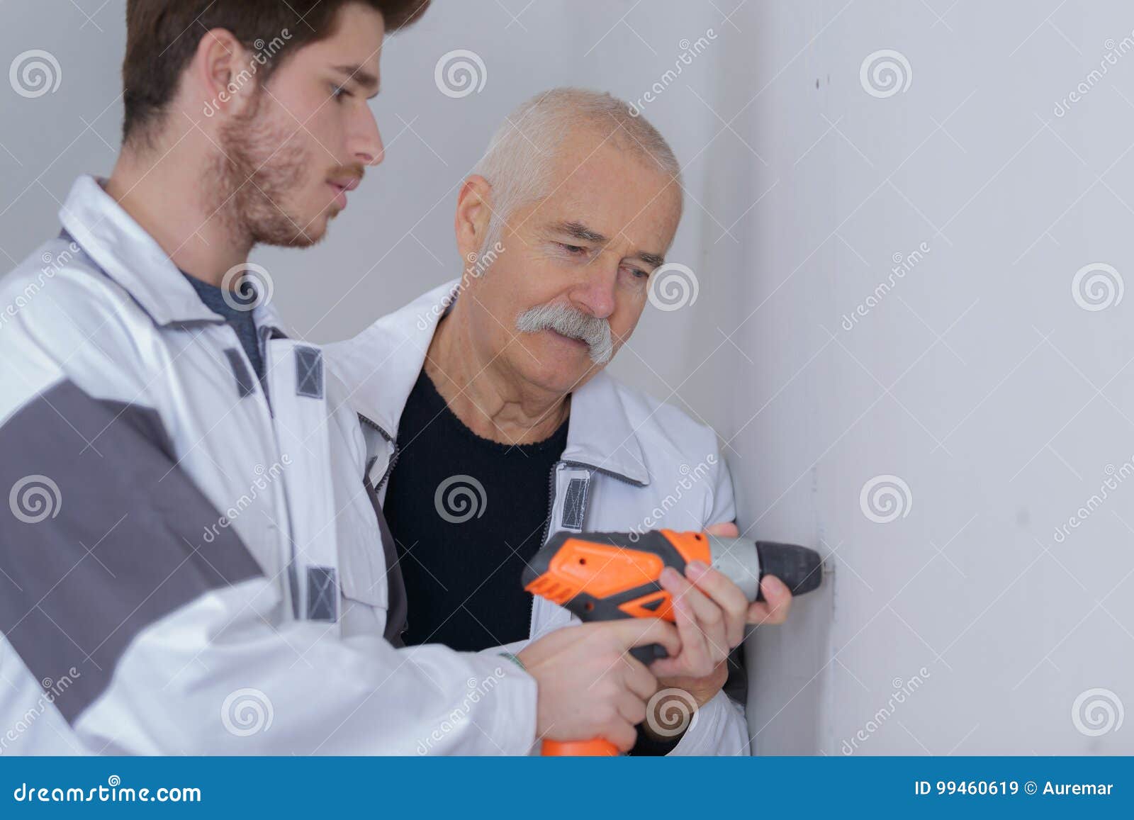 Craftsman Watching Over Male Apprentice Stock Image - Image of ...