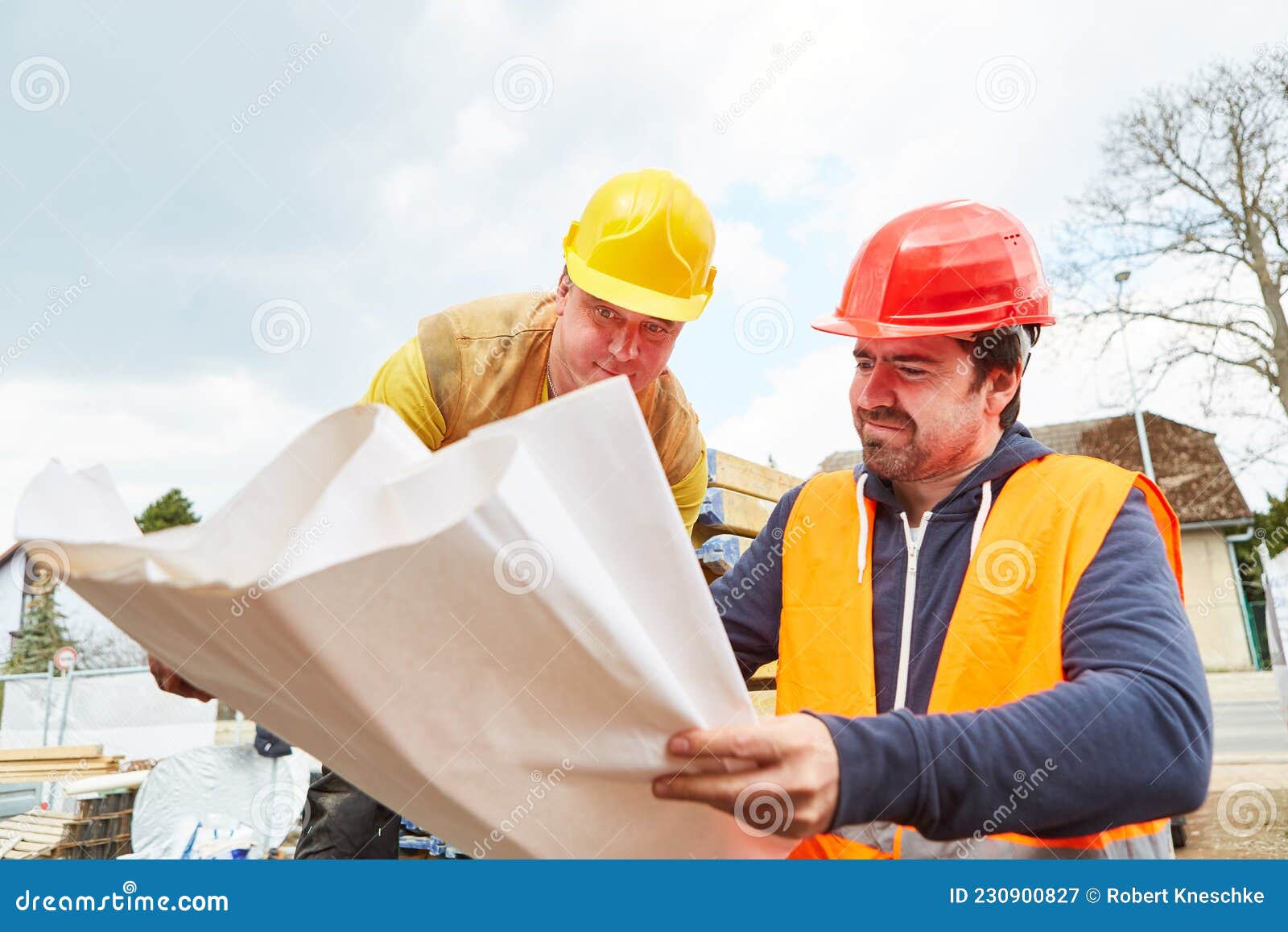Craftsmen and Architect Look at a Floor Plan Stock Image - Image of ...