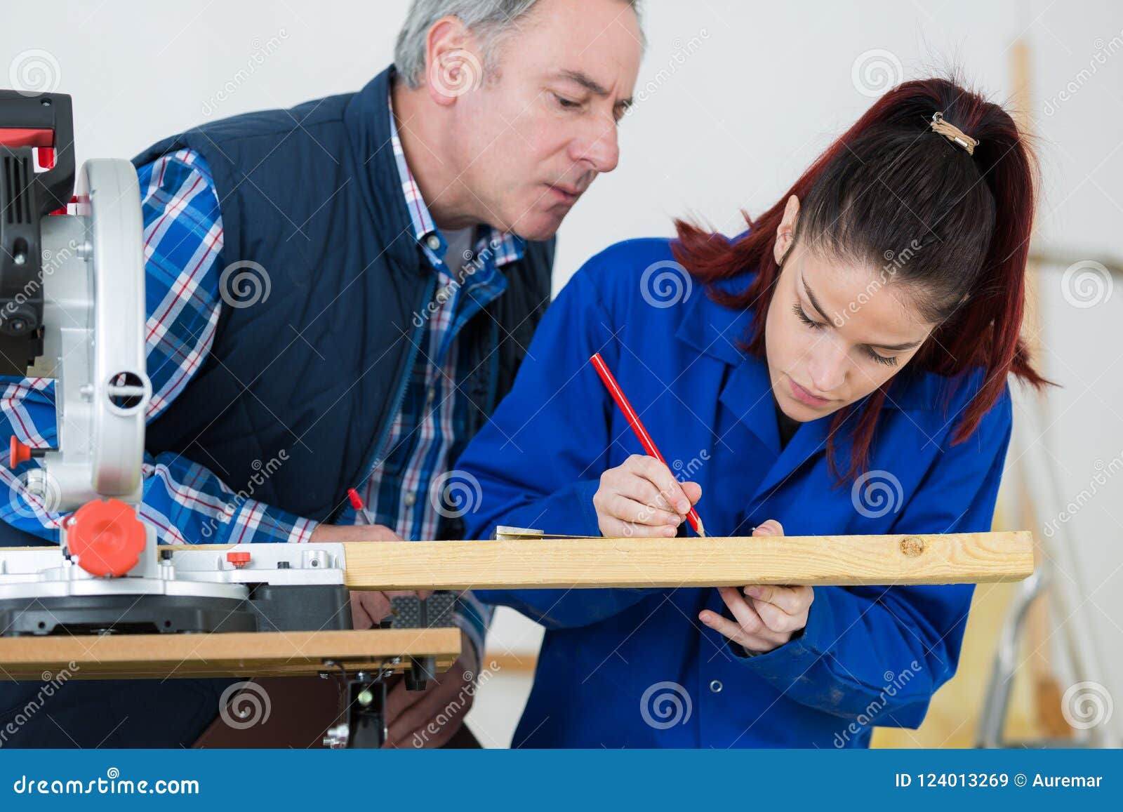 Craftsmen Supervising Female Apprentice Working Carpentry Shop Stock ...