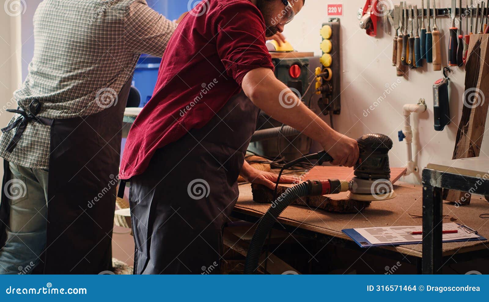 Craftsperson Uses Angle Grinder on Wood after Checking Schematics Stock ...
