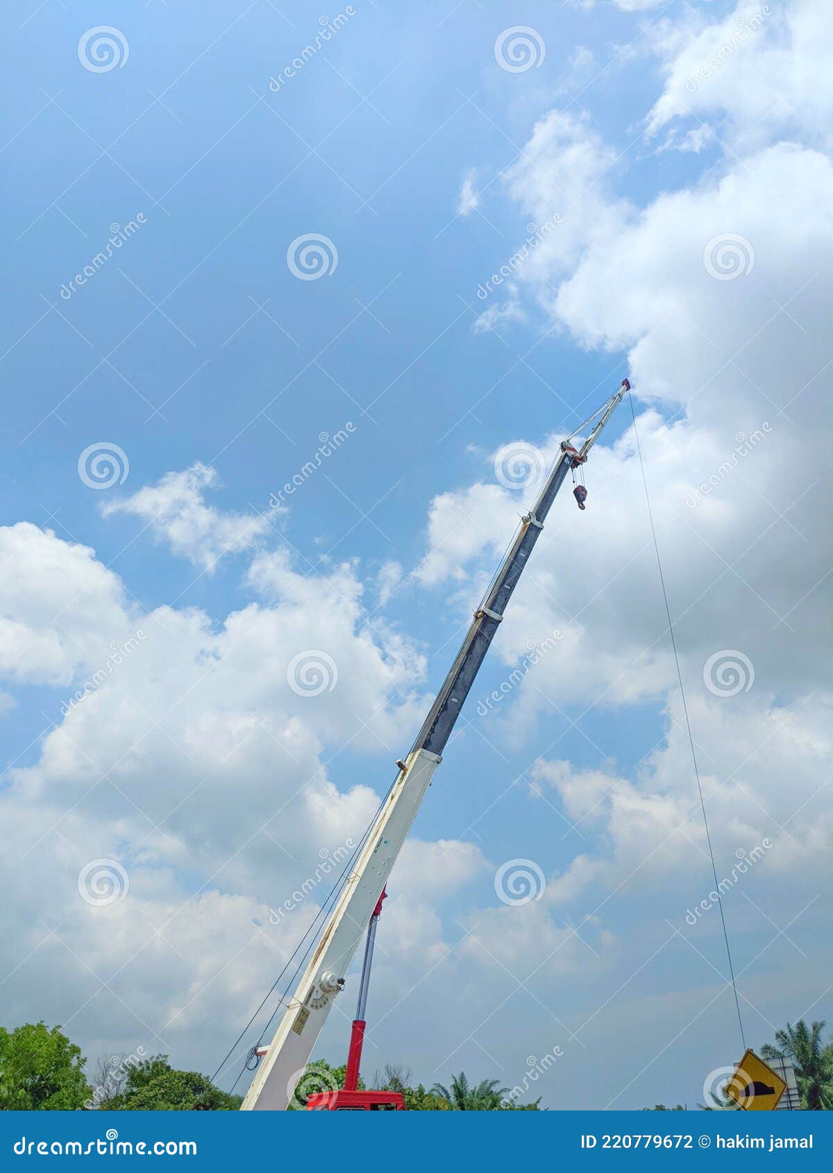 A Crain in a Construction Site on a Sunny Day with a Beautiful Blue Sky ...