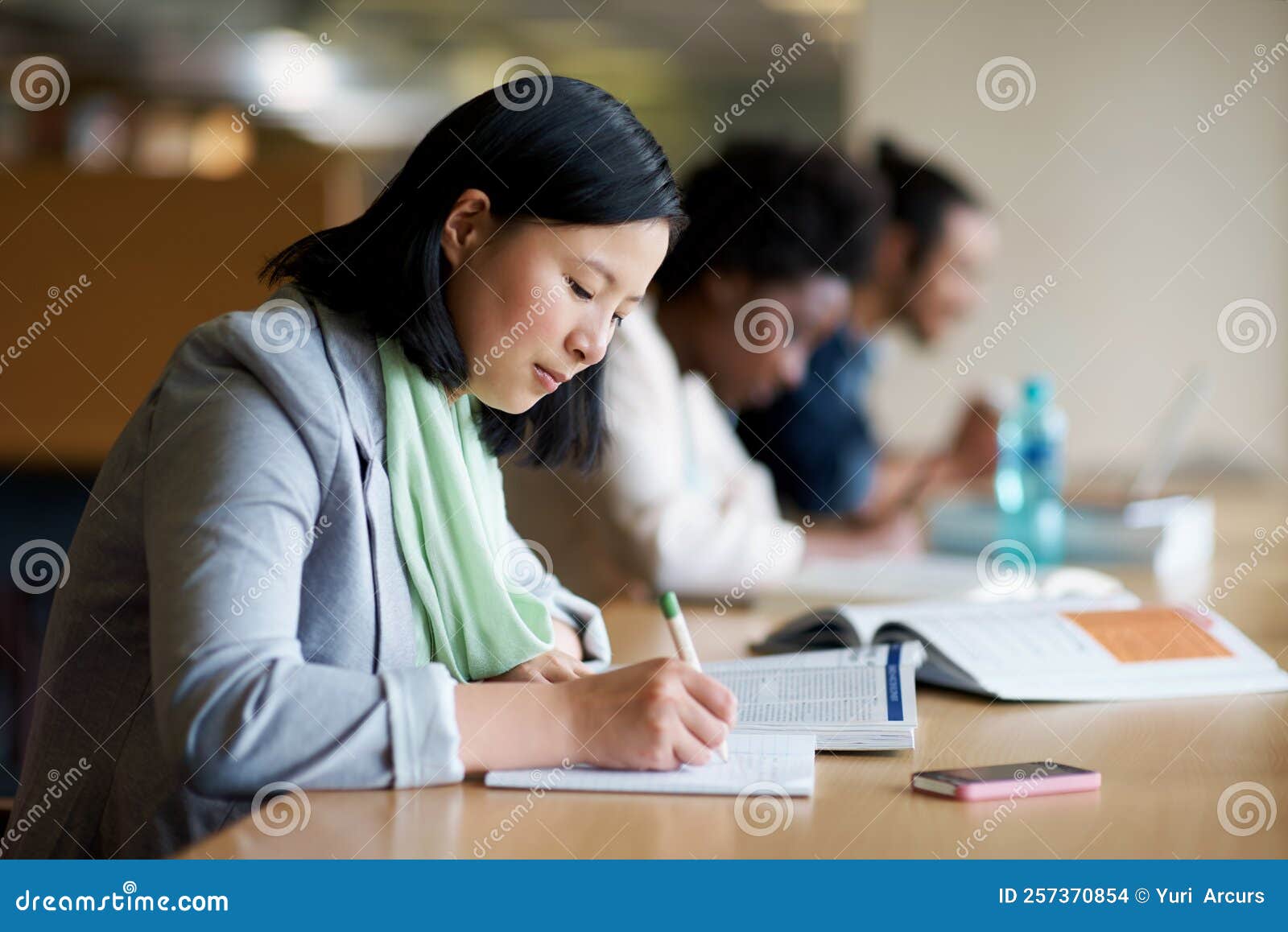 Cramming Some Last Minute Knowledge. a Young Woman Studying in the ...