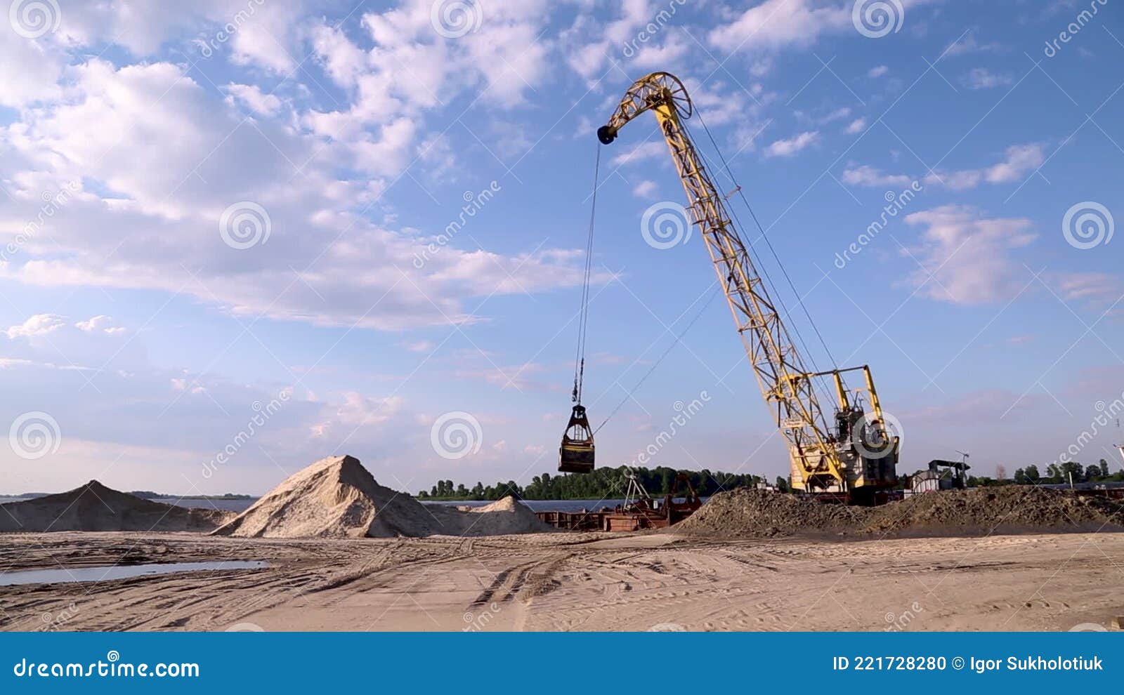 A Crane with a Bucket Unloads Wet Sand. Cargo Crane Operation Stock ...