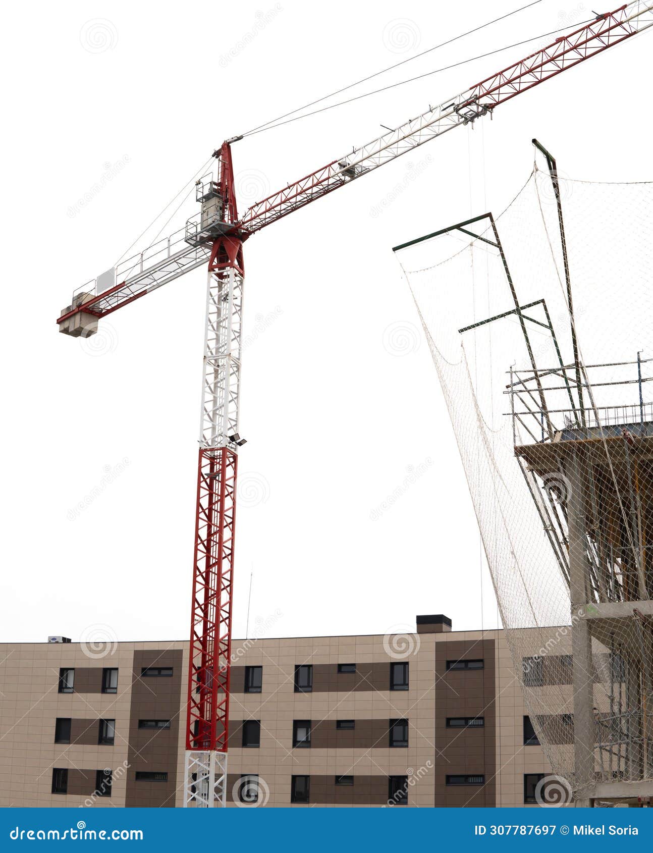 A Crane and a Building Under Construction with Safety Nets To Prevent ...