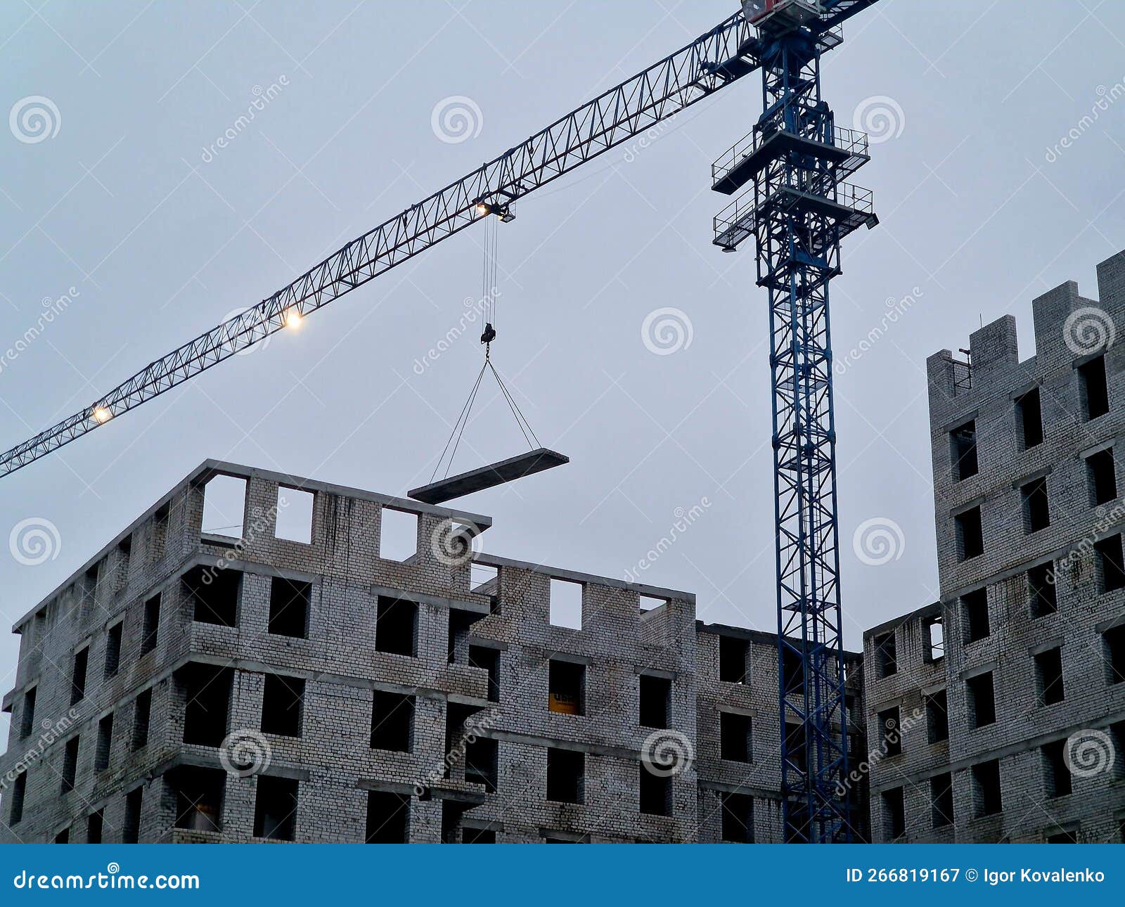Crane at a Construction Site Lifts a Concrete Slab. Stock Image - Image ...