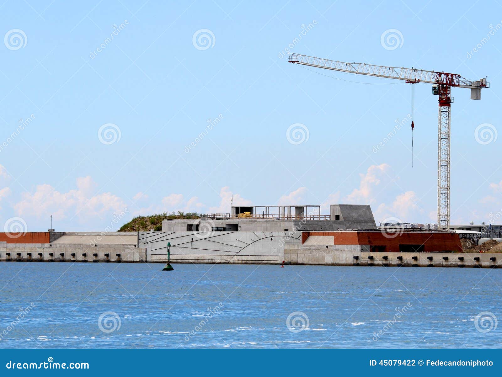 Crane in Construction Site by the Sea for the Construction of a Stock ...