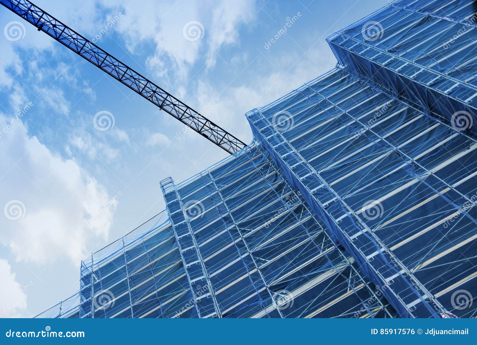 A Crane in a Construction Work. Tall Scaffold Structure from Below ...