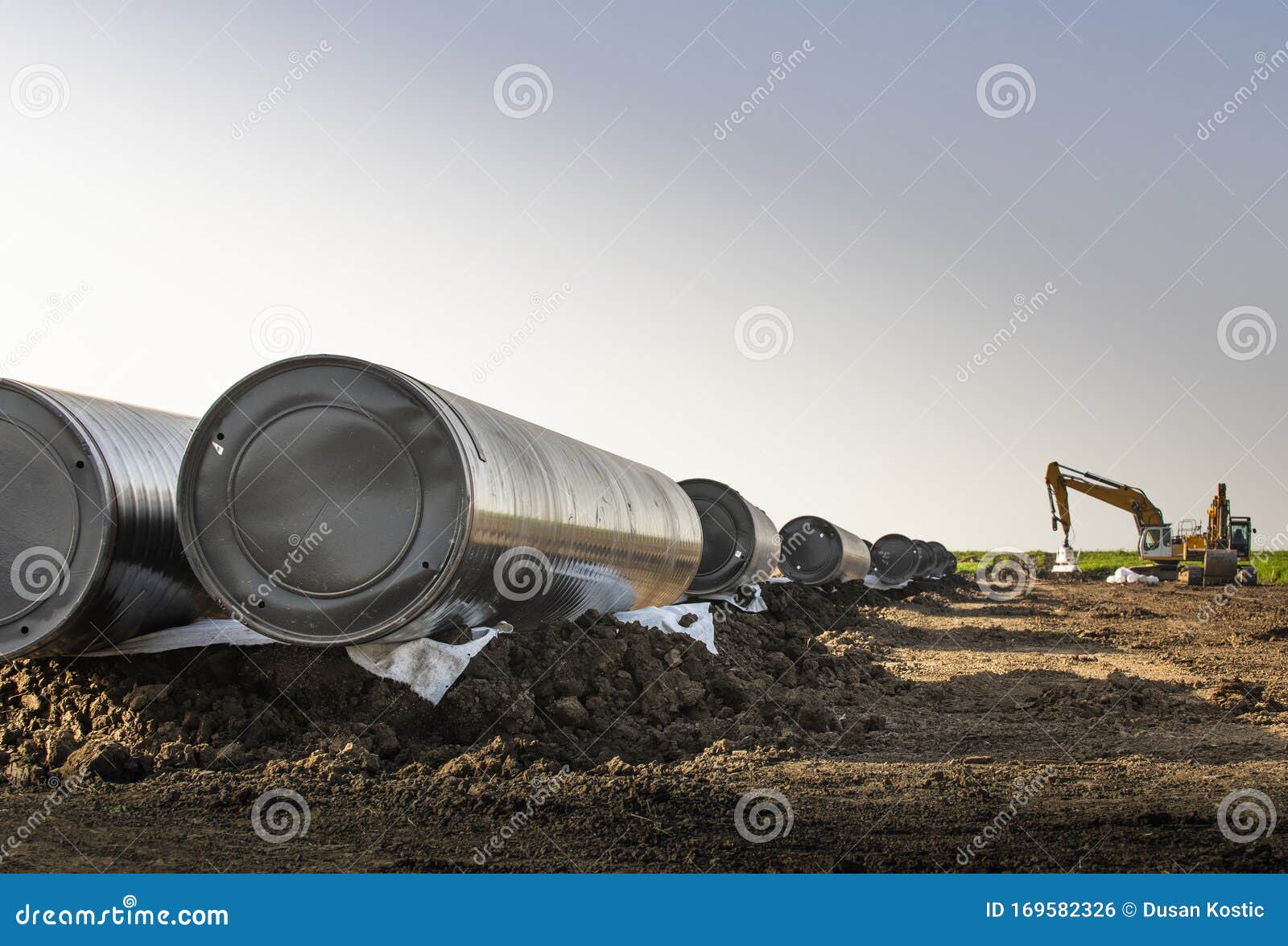 Crane Digging a Channel for Gas Pipeline Stock Photo - Image of ...