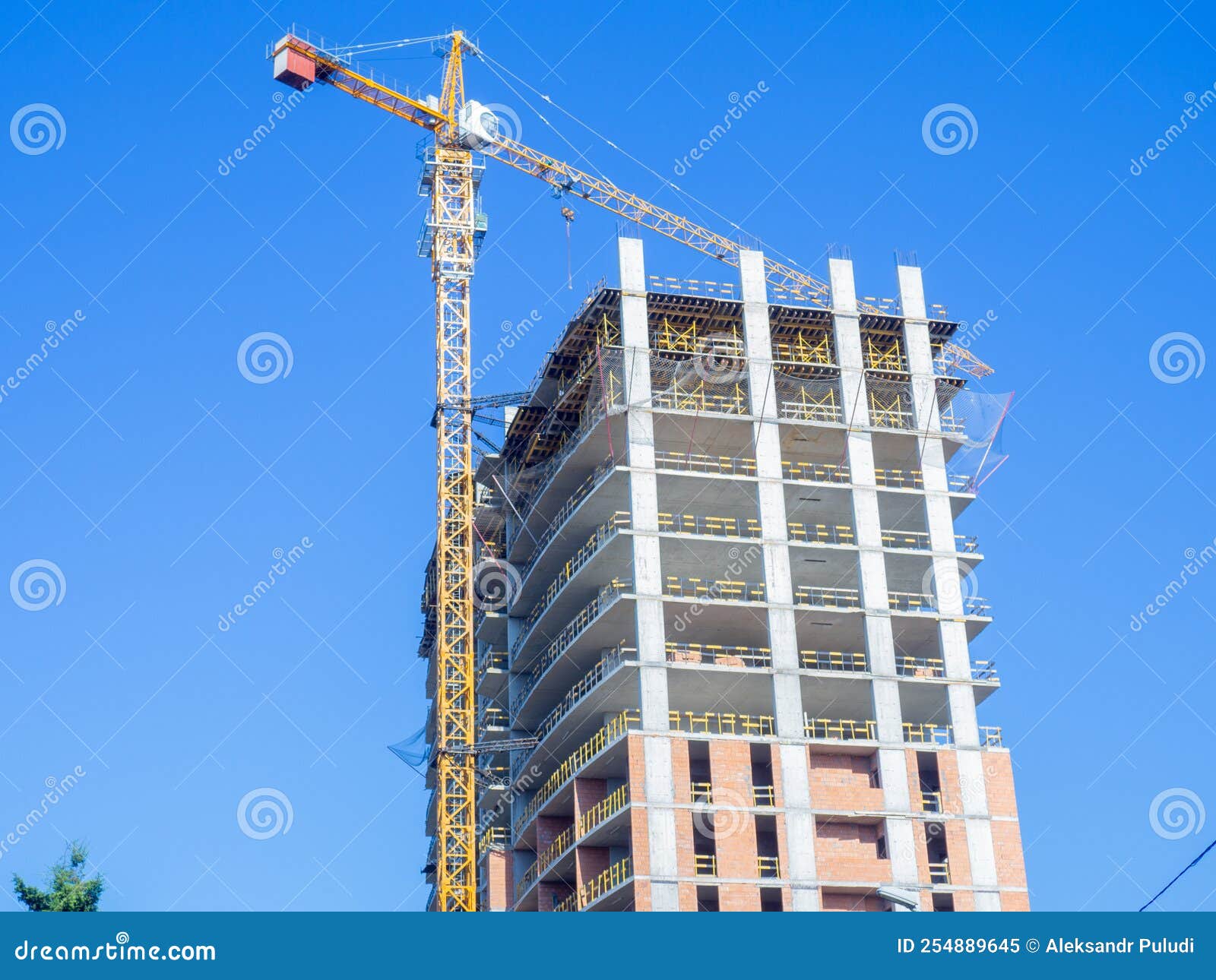 Crane and Frame of a High Concrete House. Construction Works. Concrete ...