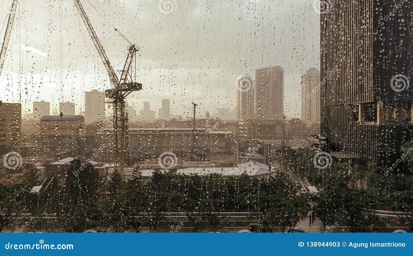A Crane in Heavy Rain is Working on Building a Skyscraper Stock Image ...