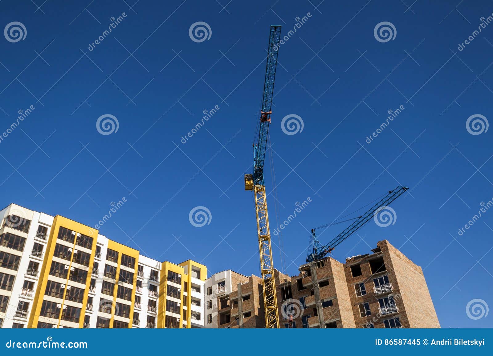 Crane and High Rise Building Under Construction Against Blue Sky Stock ...