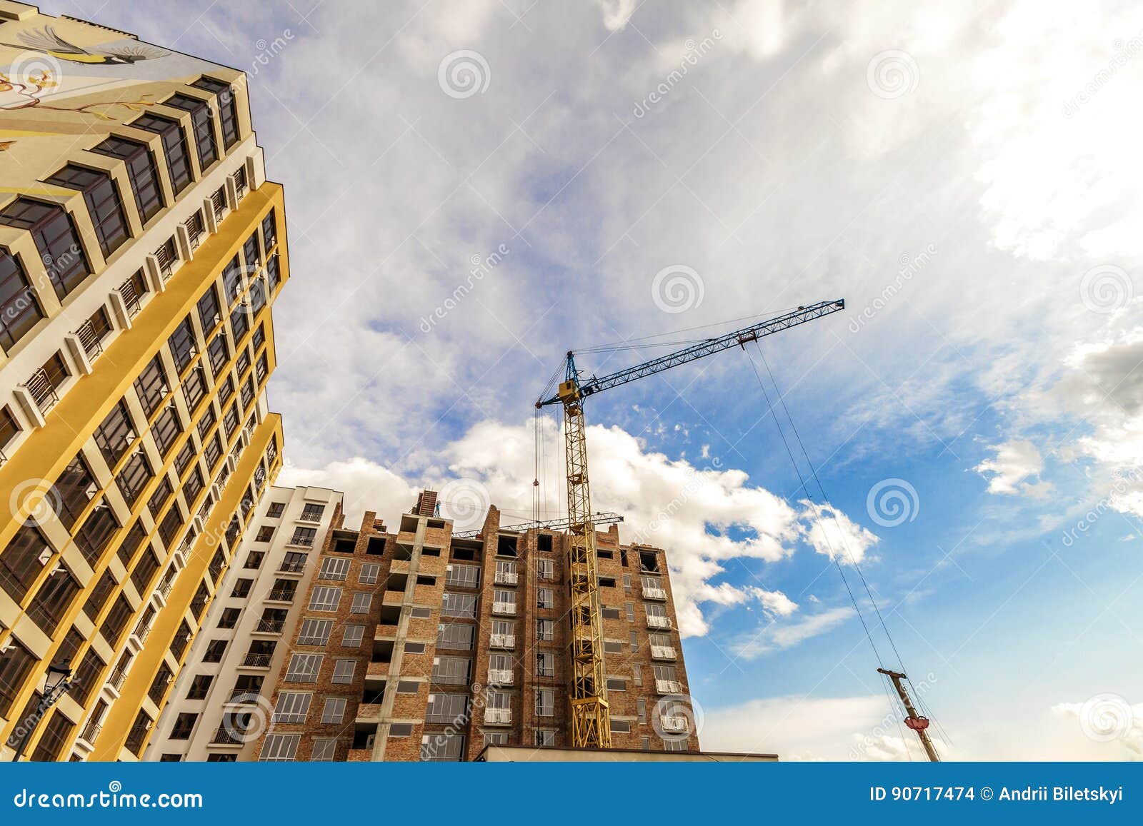 Crane and High Rise Building Under Construction Against Blue Sky Stock ...