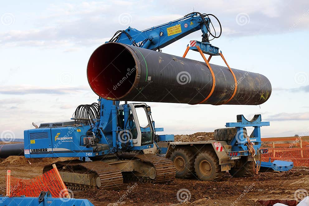 Crane loading a big tube editorial stock photo. Image of high - 23825608