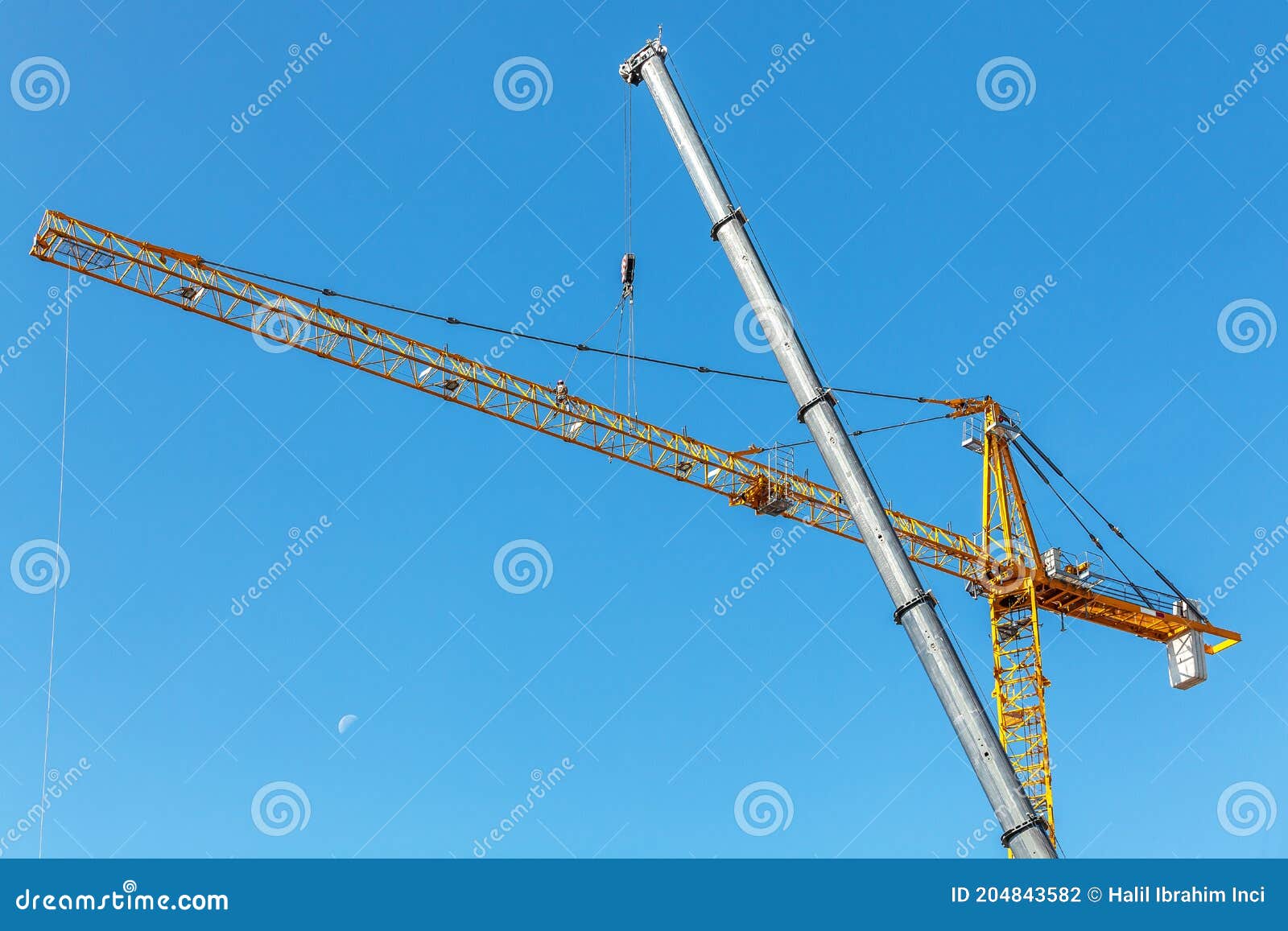 Crane montage in sunny day stock photo. Image of construction - 204843582