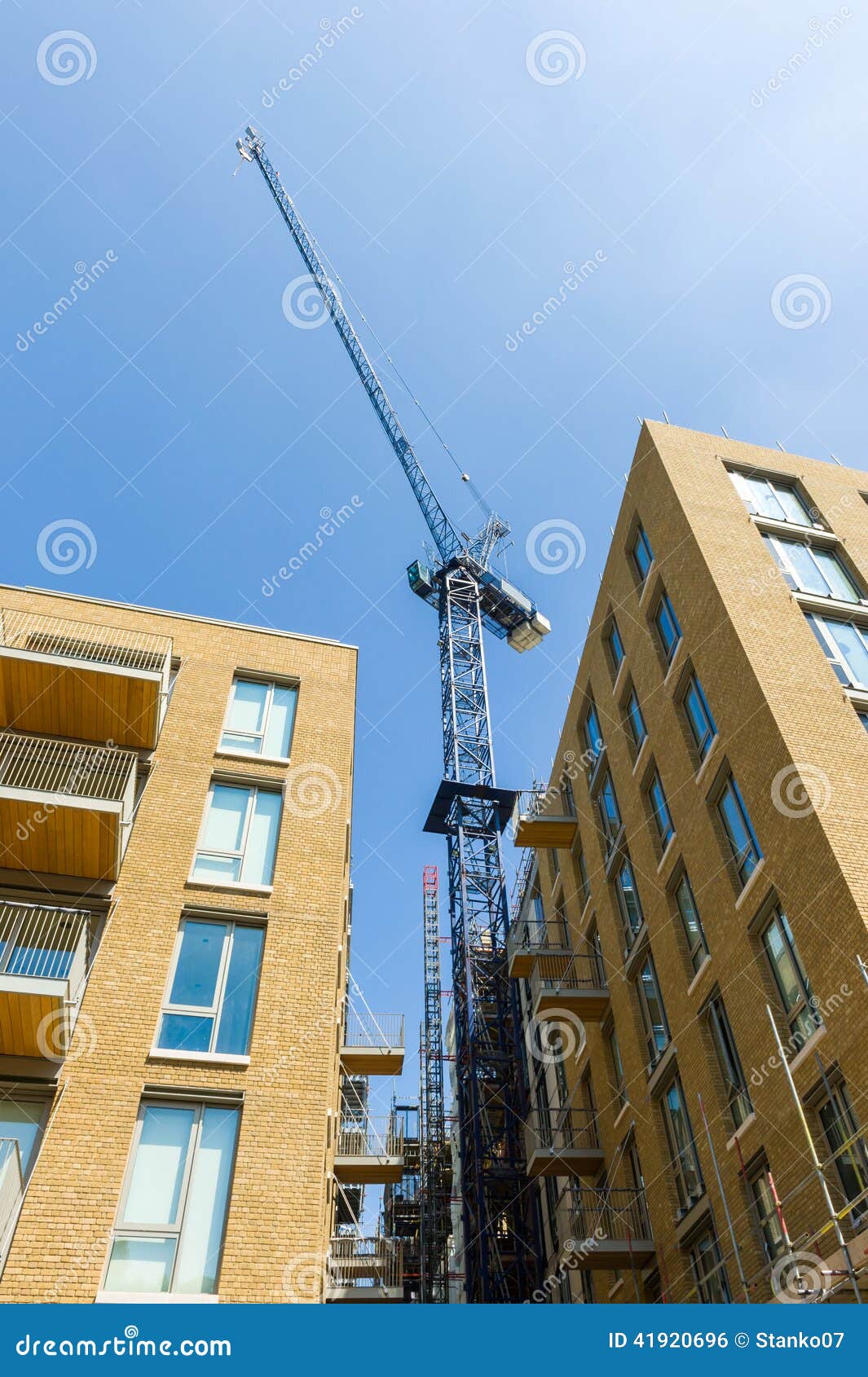 Crane over the buildings. stock photo. Image of floor - 41920696