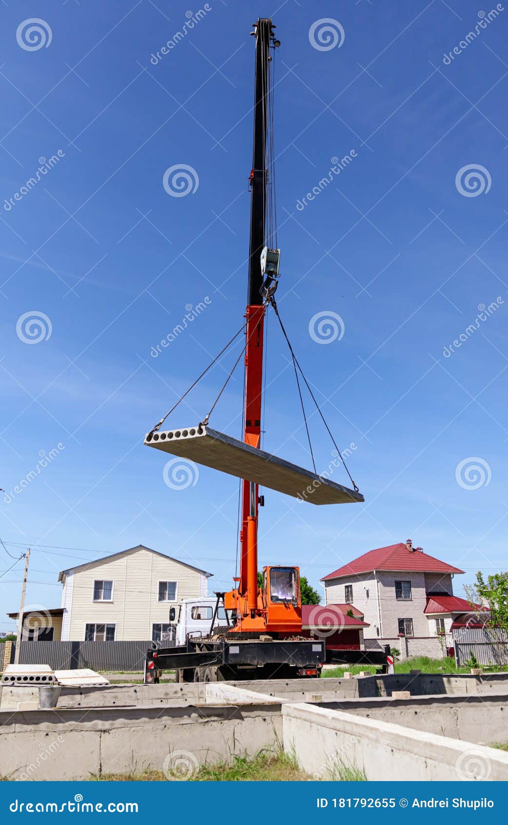 A Crane Raised a Concrete Slab at a Construction Site at Home Stock ...