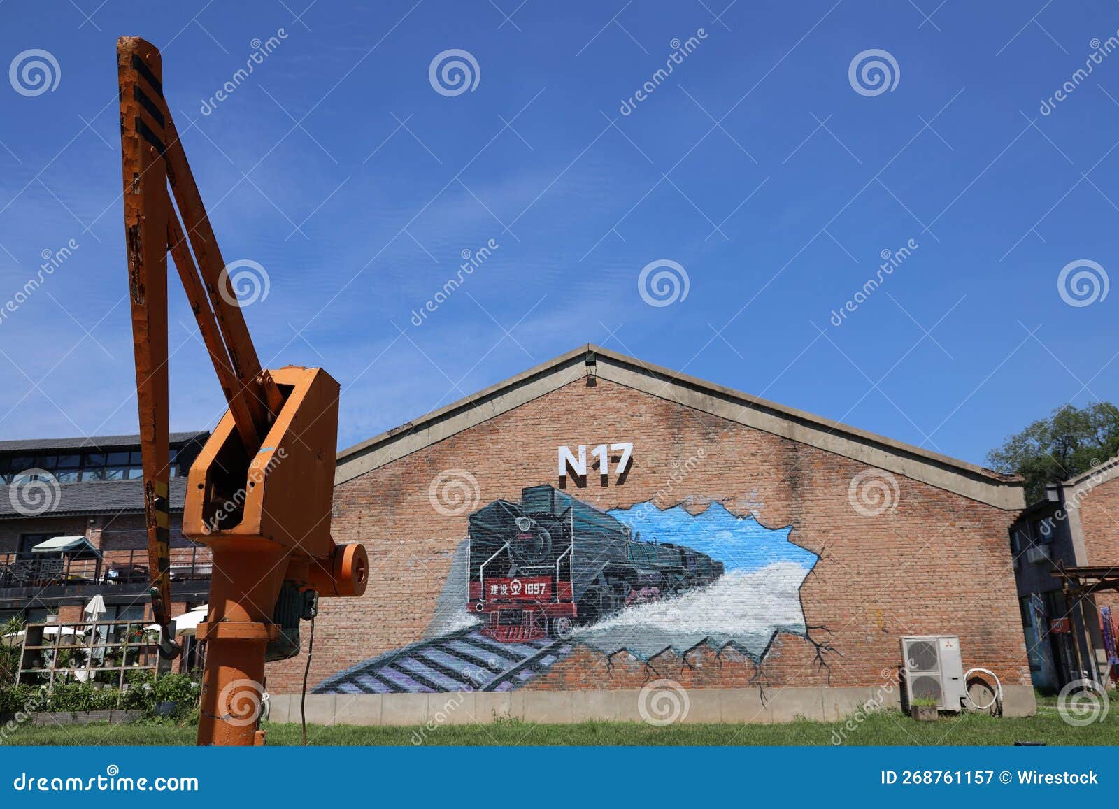 Crane and Train Graffiti on a Wall Behind it in Erqi Factory 1897 ...