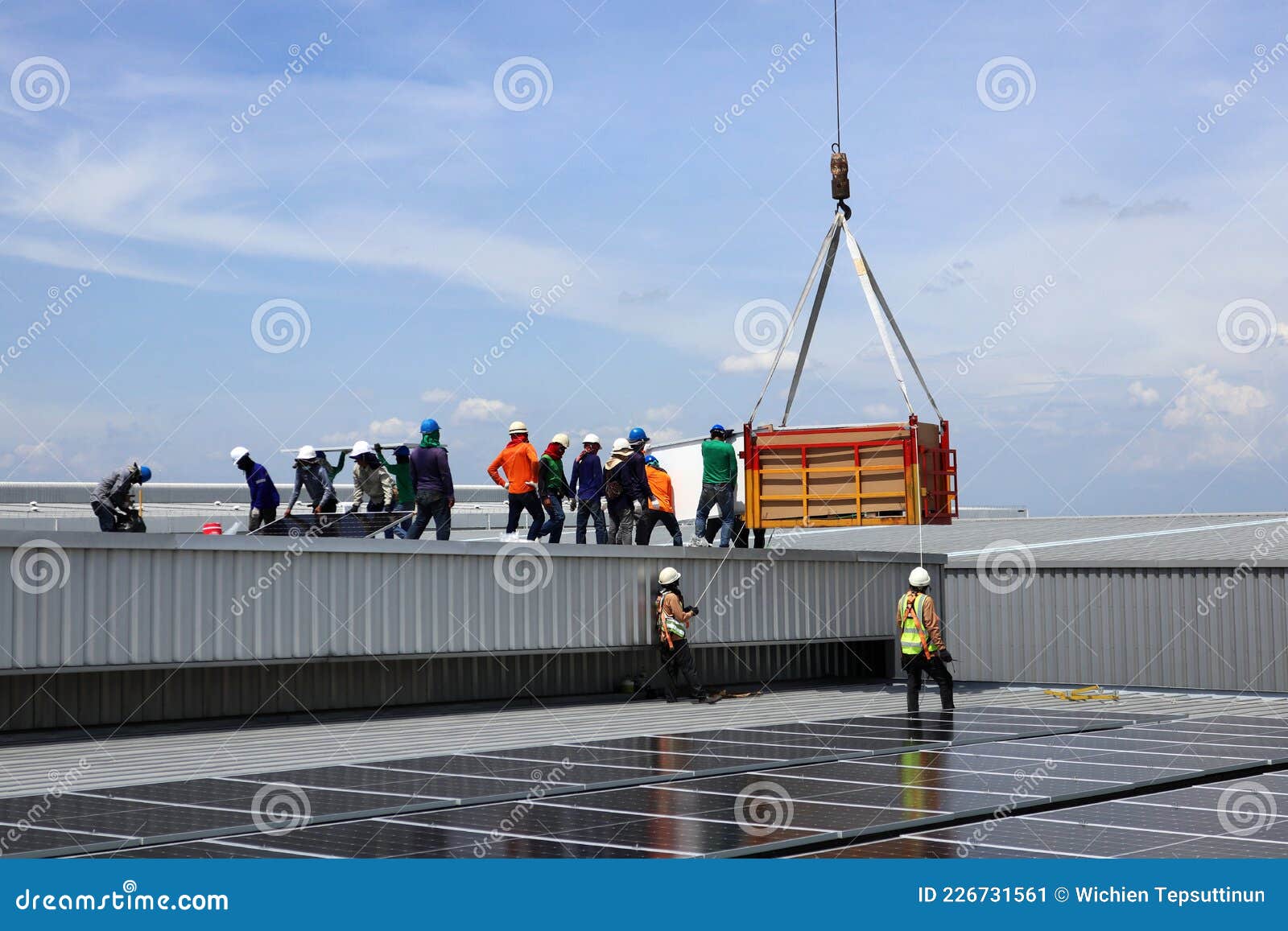 Crane Uploading Solar PV Panels on Roof with Installation Workers Stock ...