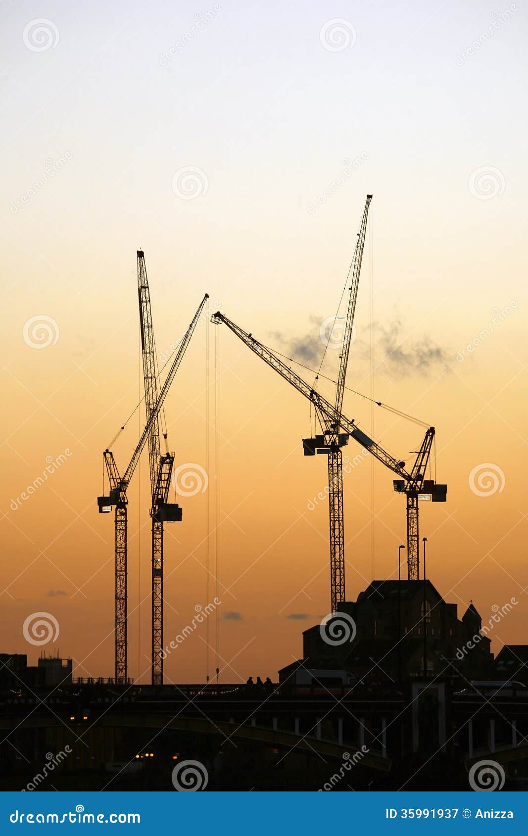 Cranes working over sunset stock image. Image of tall - 35991937