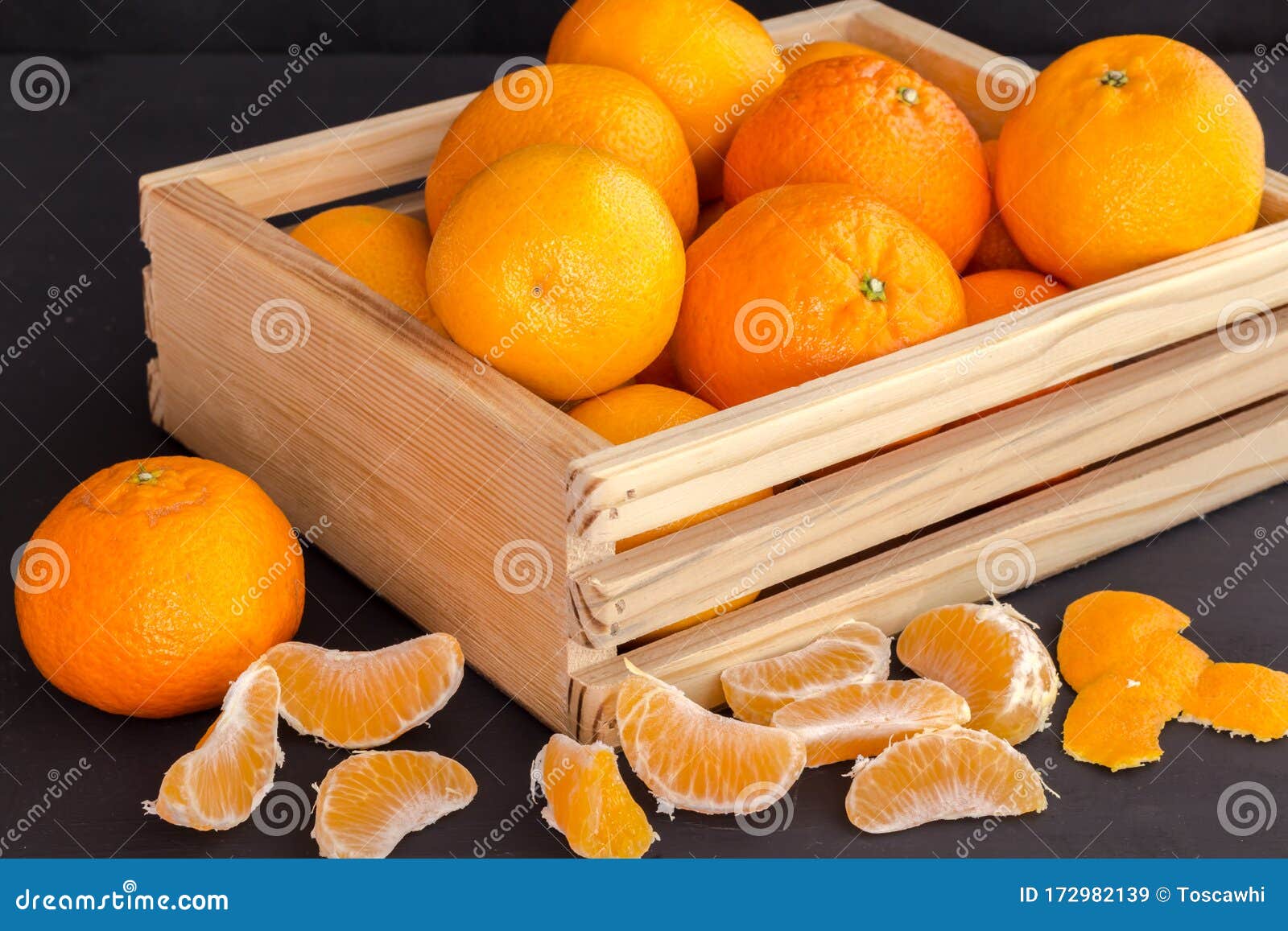 Crate of Oranges with Orange Segments Isolated on Rustic Black ...