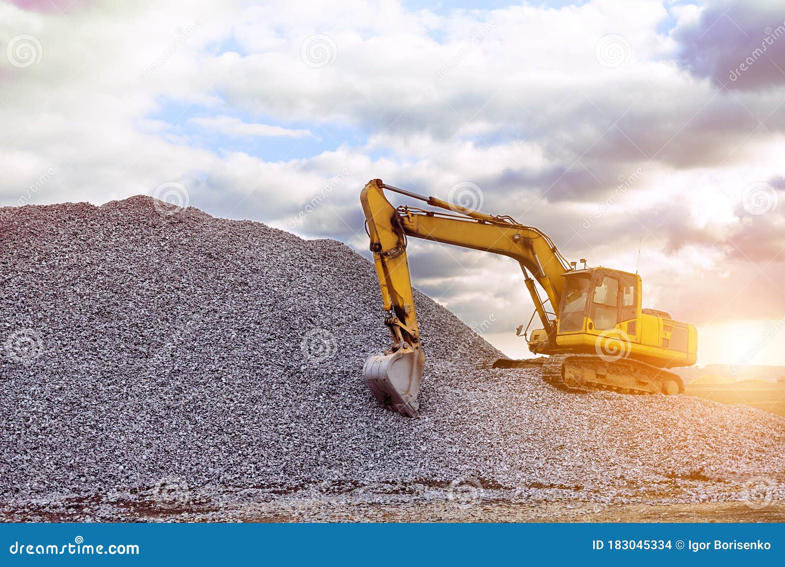 Crawler Excavator in the Rays of the Setting Sun at Sunset Digs Earth ...