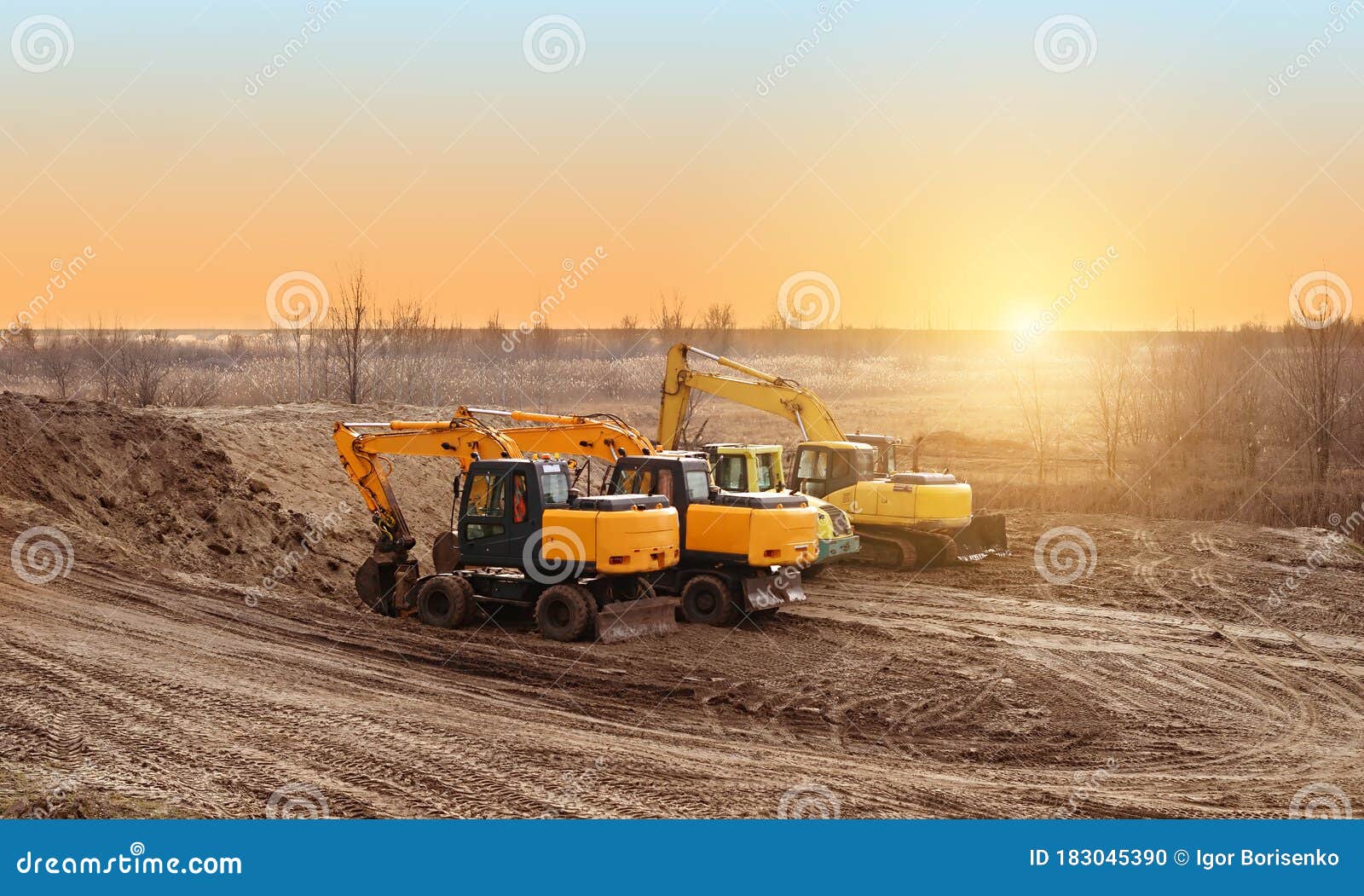 Crawler Excavator in the Rays of the Setting Sun at Sunset Digs Earth ...