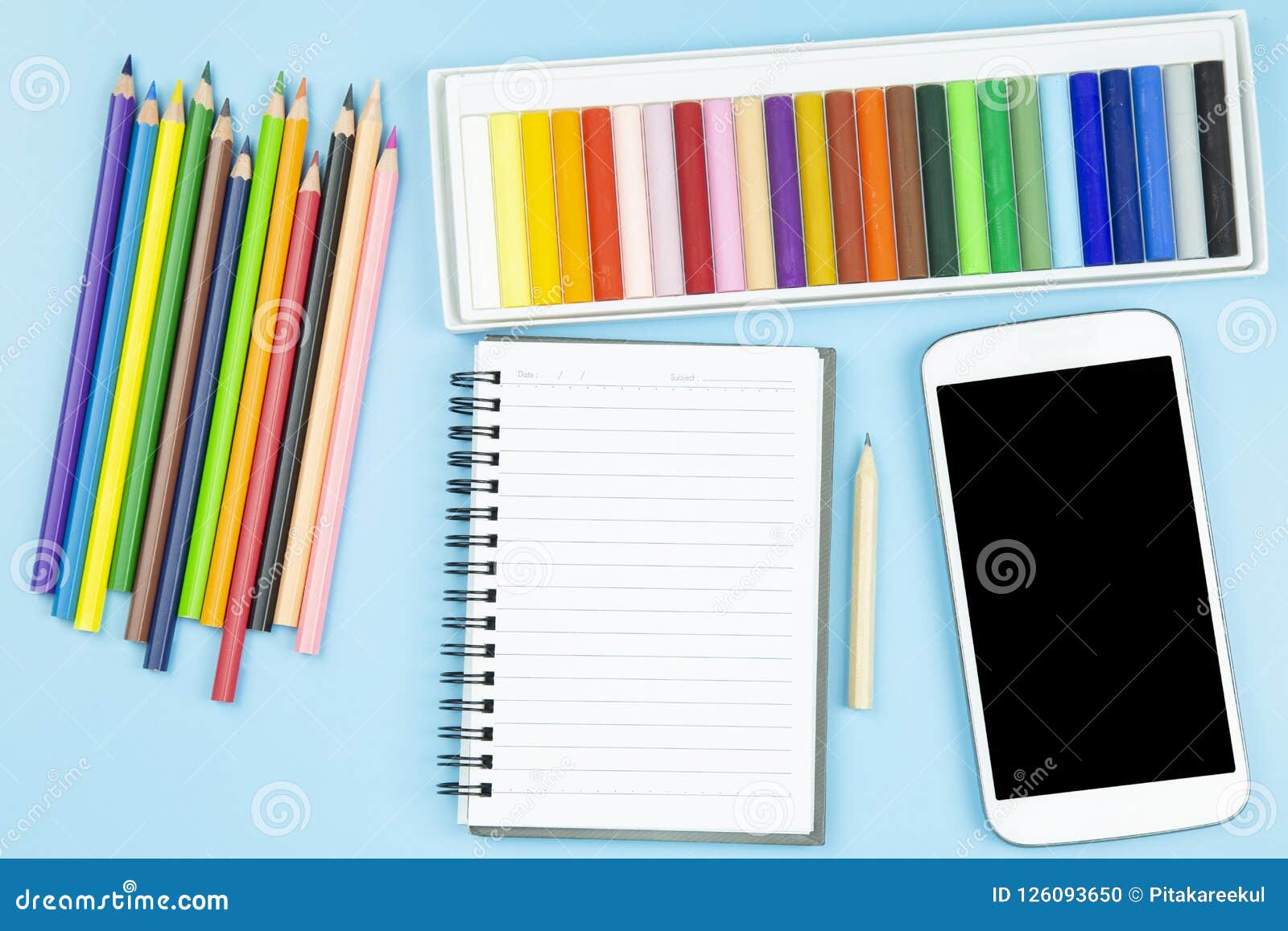Crayon and Book Mobile Phone Topview Flatlay on Blue Background Stock ...