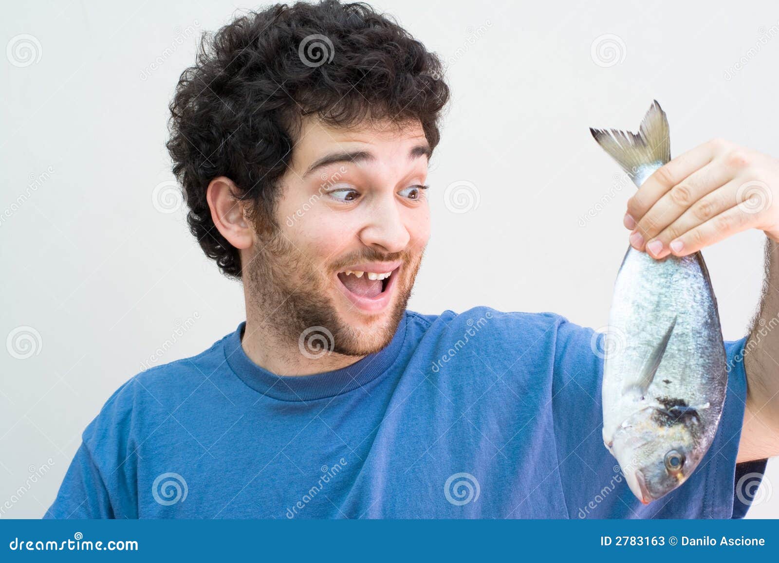 Crazy man holding a fish stock image. Image of happyness - 2783163