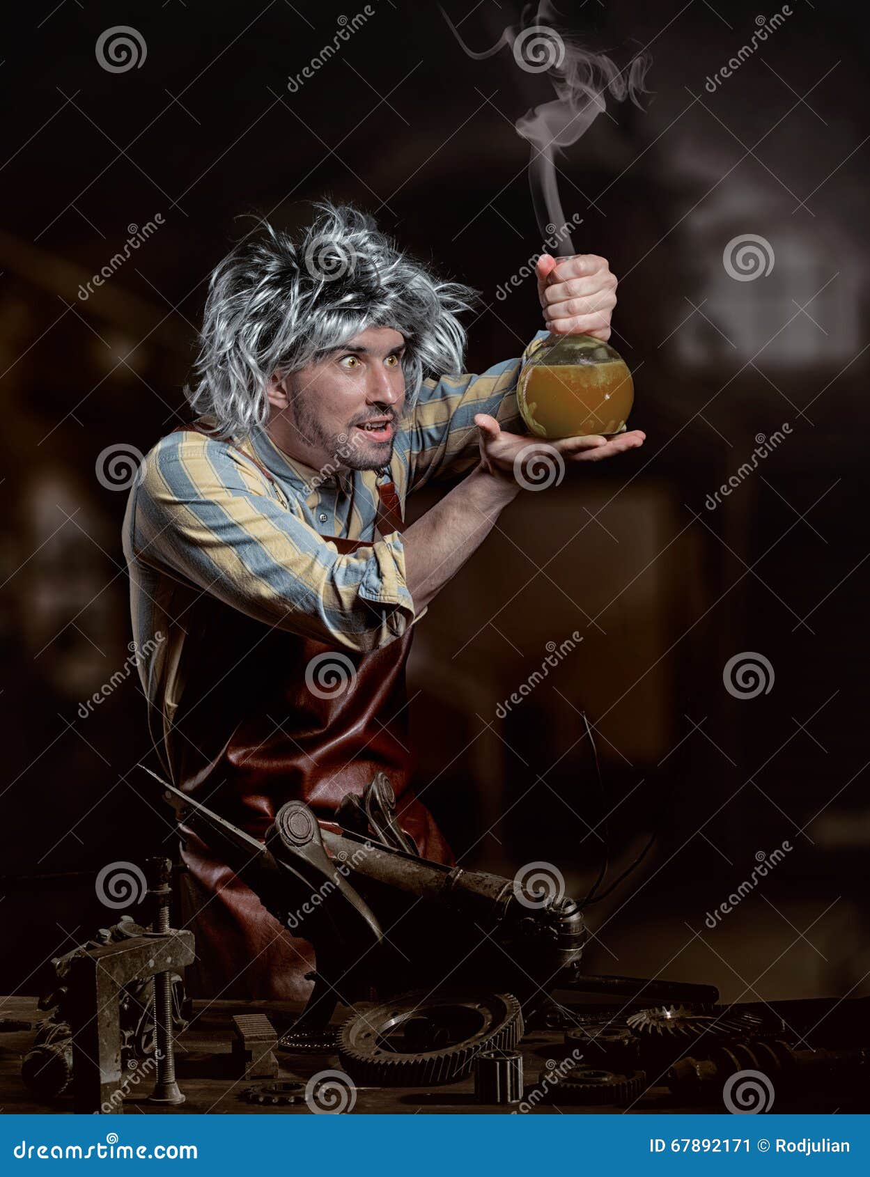 Crazy Scientist With Goofy Look Grabbing Glass Test Tubes Sitting In ...