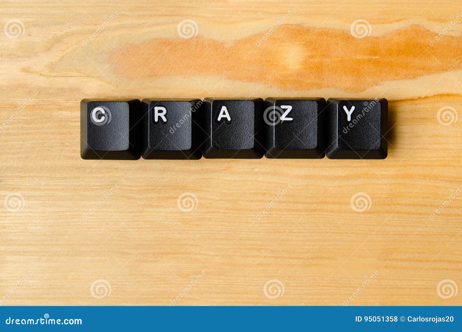 Crazy Word Composed With Multi Colored Stone Letters Over Green Sand ...