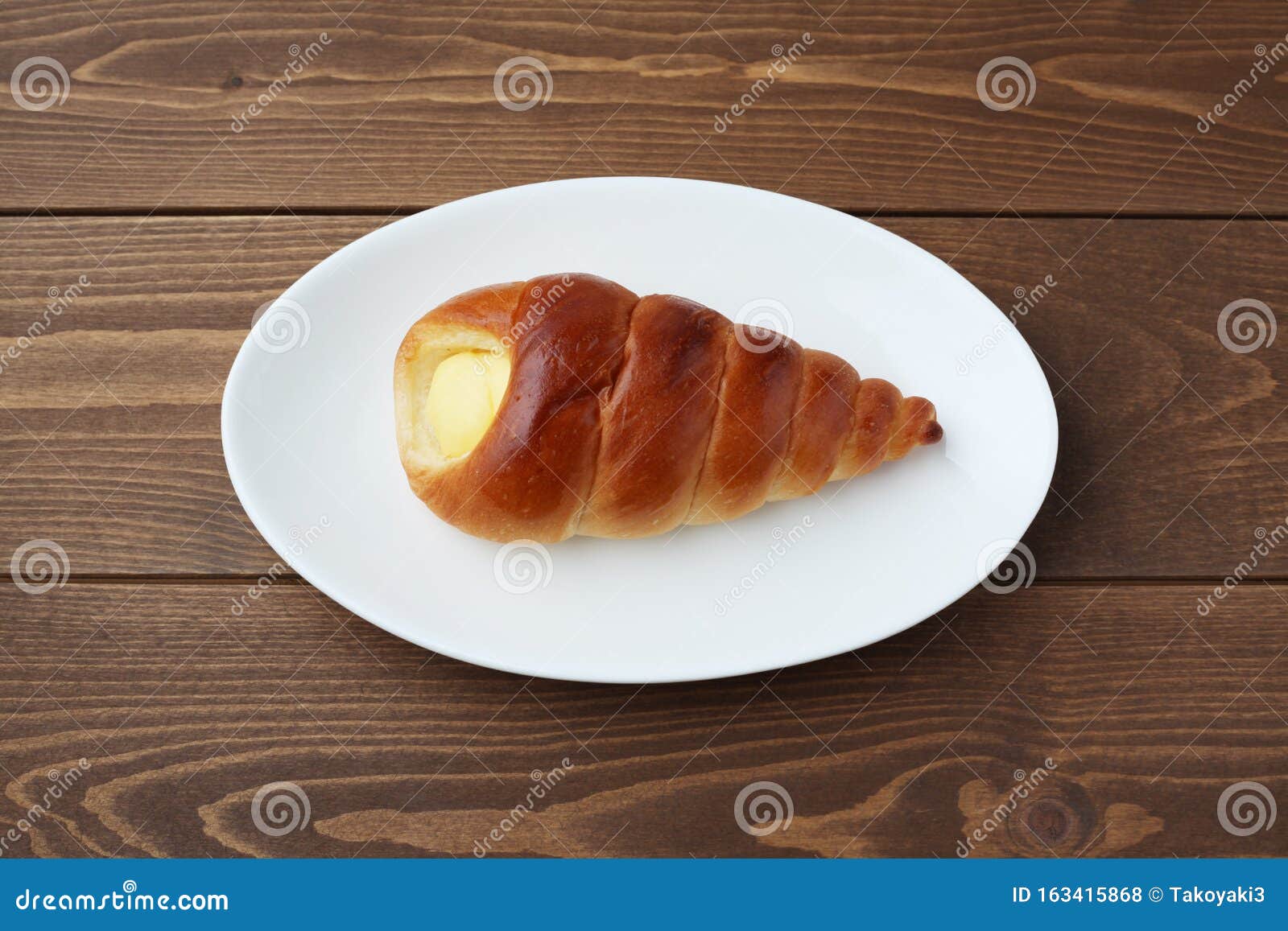 Cream Cornet Roll Bread on Plate Isolated on Table Stock Photo - Image ...