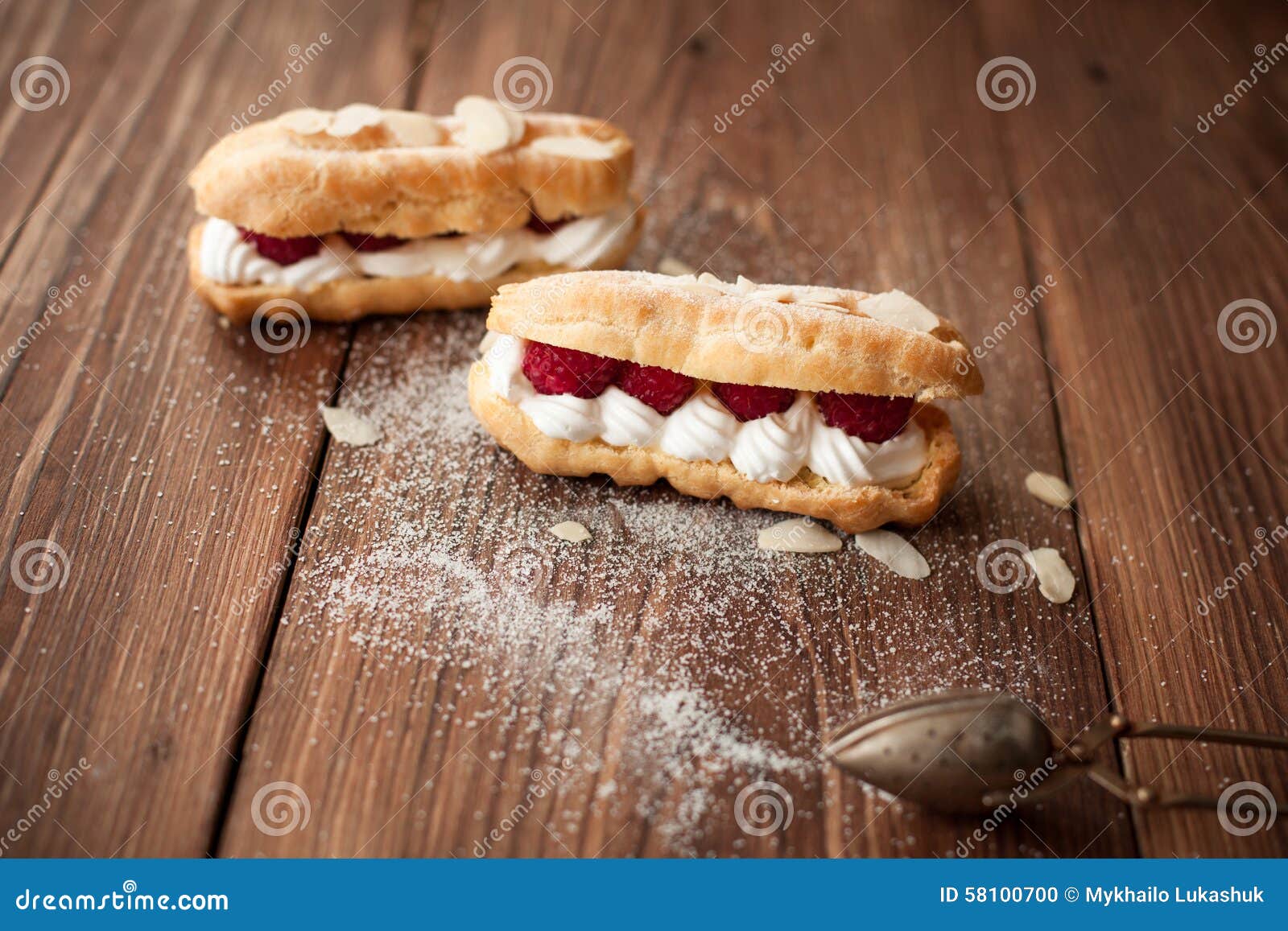 Cream Eclairs with Fresh Raspberries on Wood Table Stock Photo - Image ...