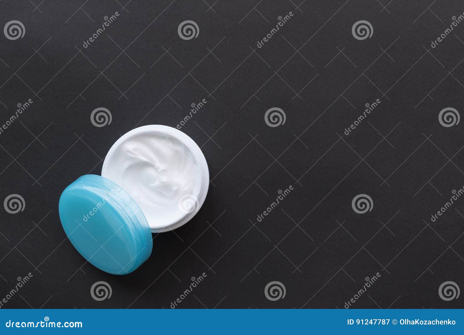 Cream for Face or Body in a White Container and Blue Lid on Black ...