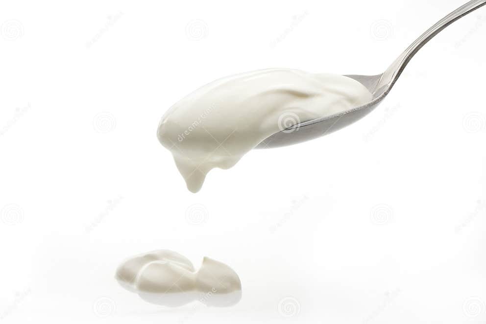 Cream in spoon isolated stock photo. Image of twirl, foam - 43706650