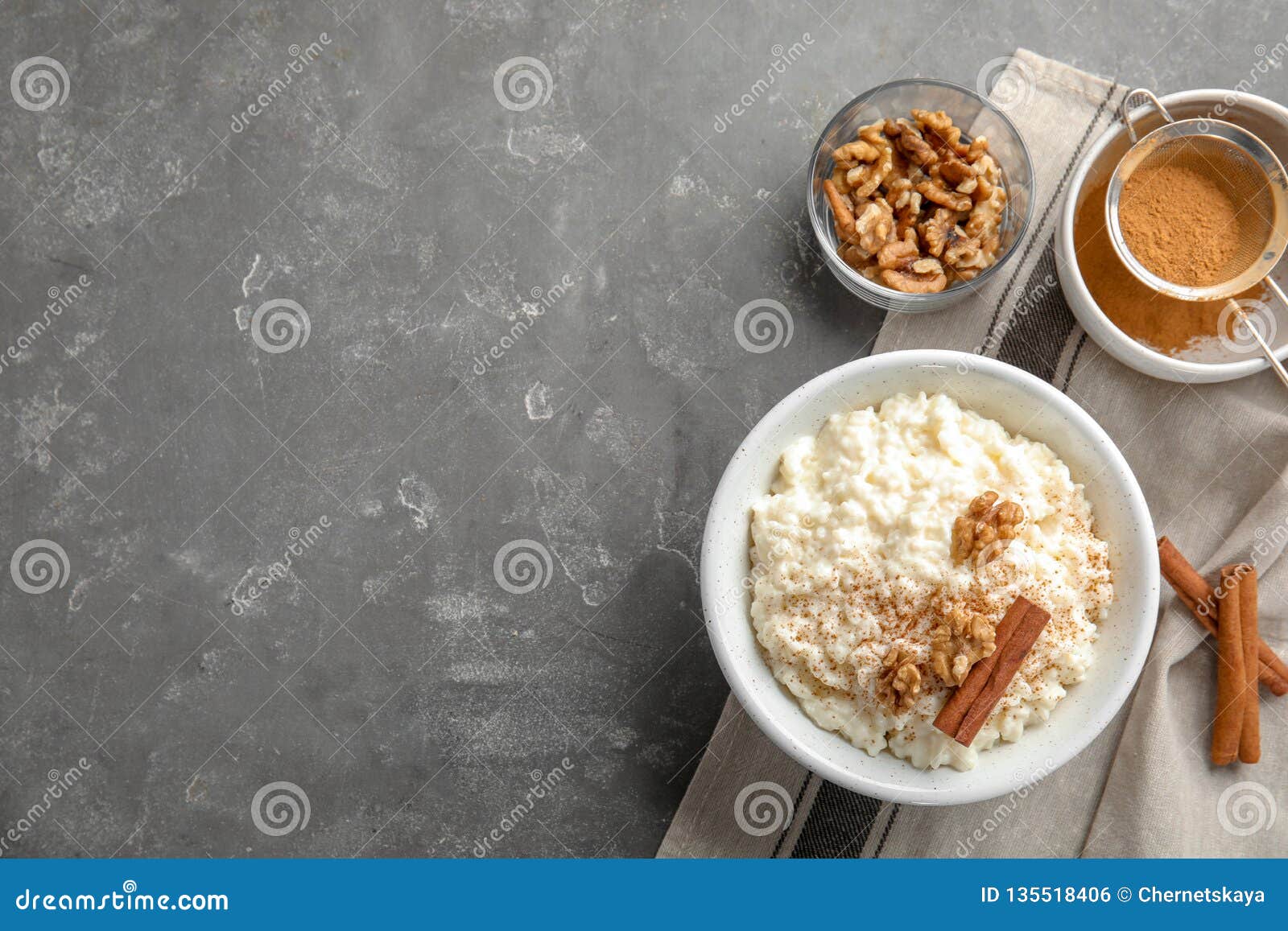 Creamy Rice Pudding with Cinnamon and Walnuts in Bowl Served on Grey ...