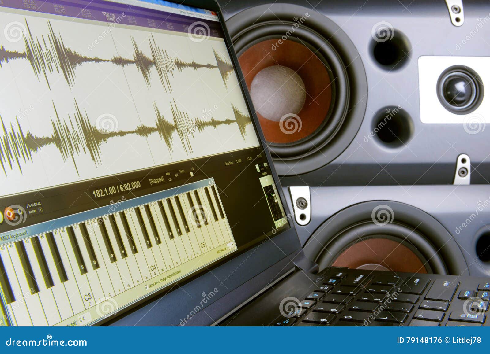 Creating Music in a Editor on the Laptop, Blurred Background Speakers ...