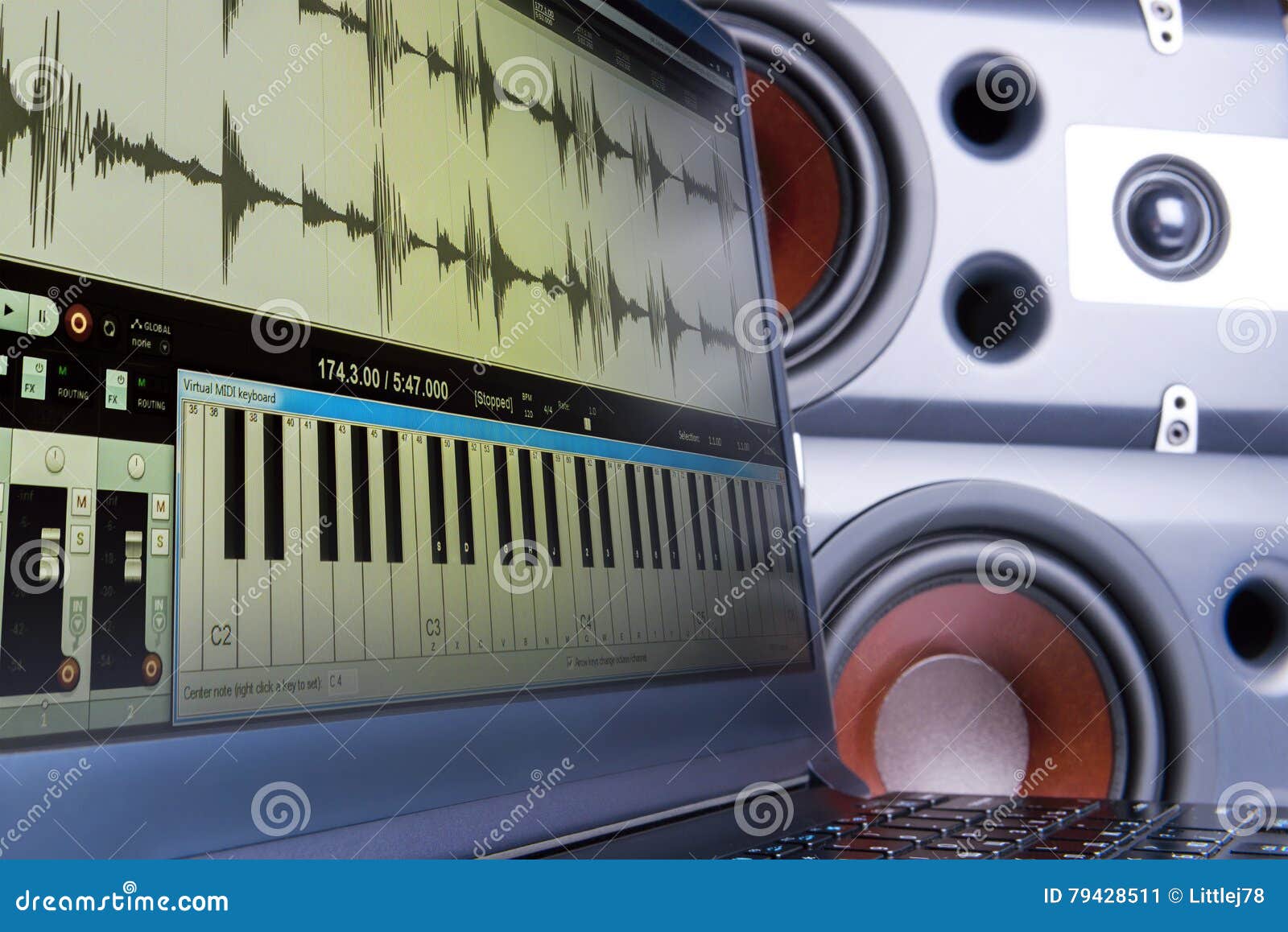 Creating Music in a Editor on the Laptop, Blurred Background Speakers ...