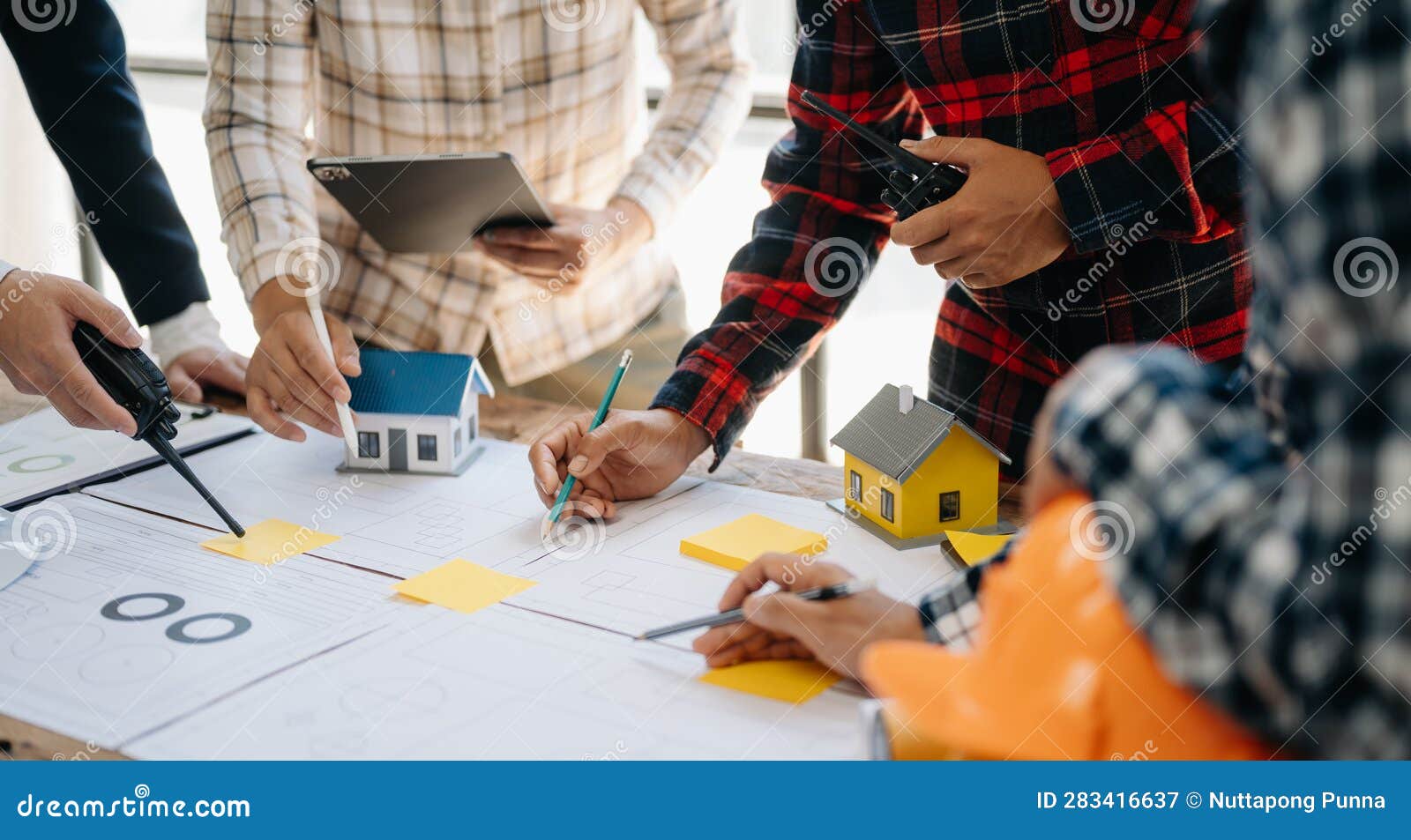 Three Colleagues Discussing Data Working and Tablet, Laptop with on on ...