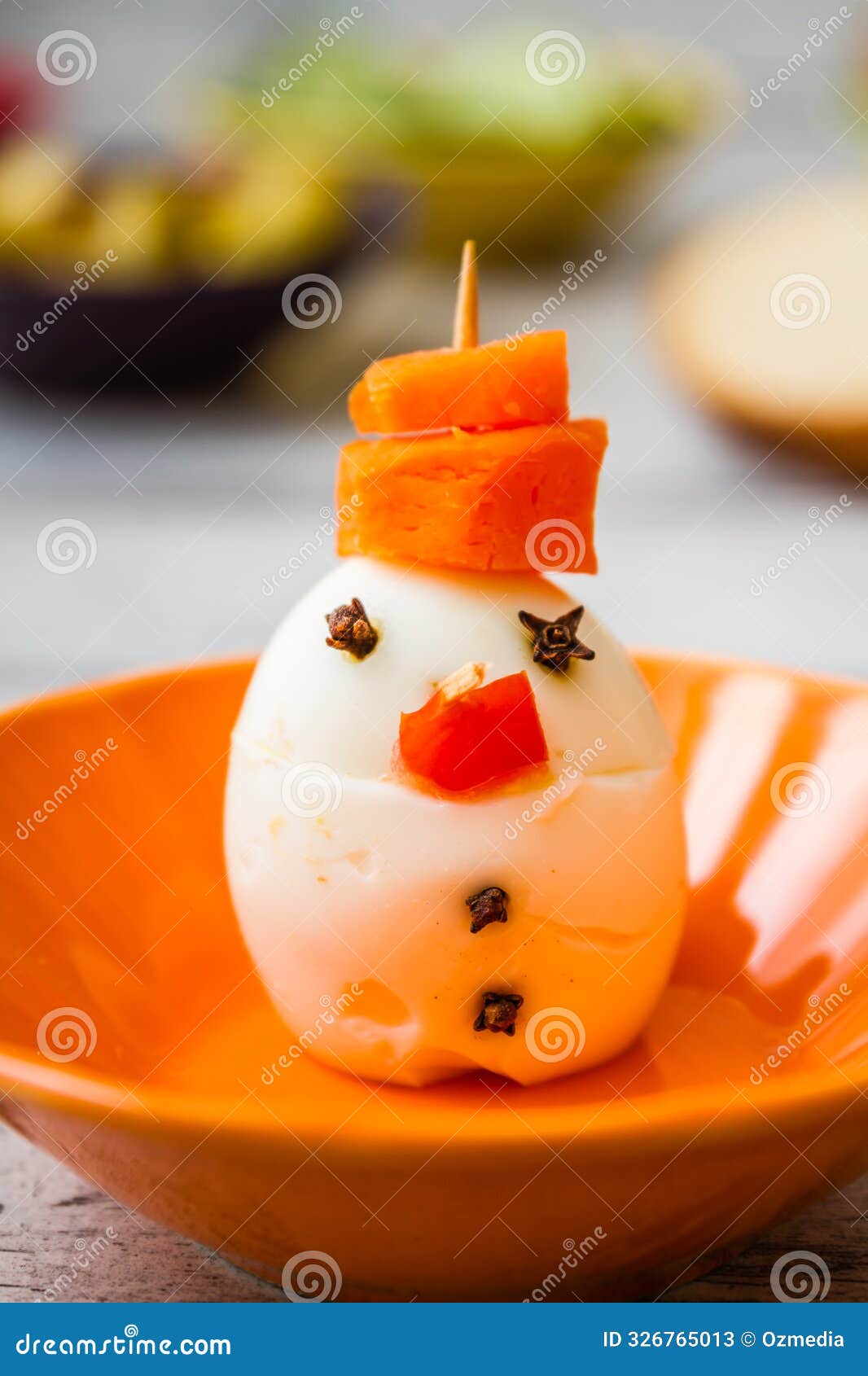Creative Breakfast Dish with an Egg and Vegetable Snowman on an Orange ...