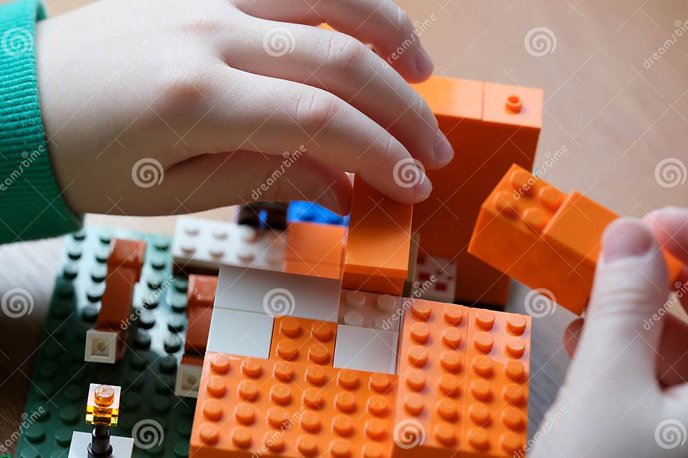 Creative Building with Bright Orange Blocks at a Cozy Workspace ...