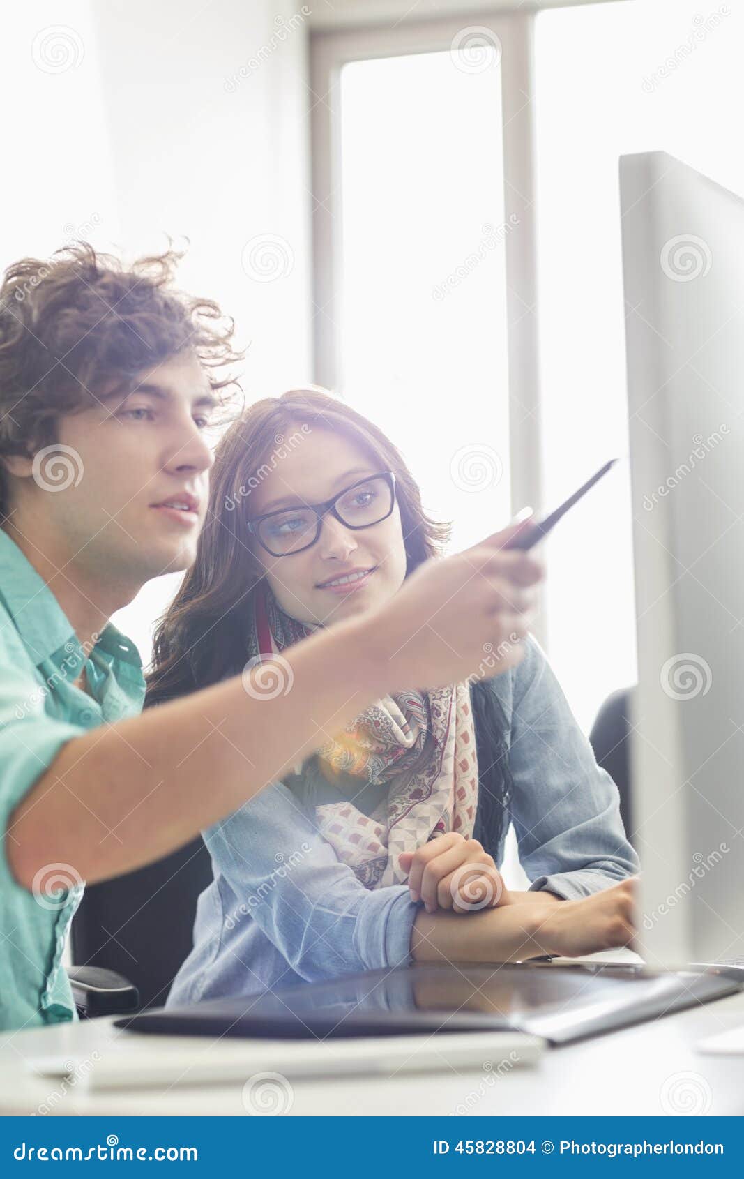 Creative Business Colleagues Discussing Over Desktop Computer in Office ...